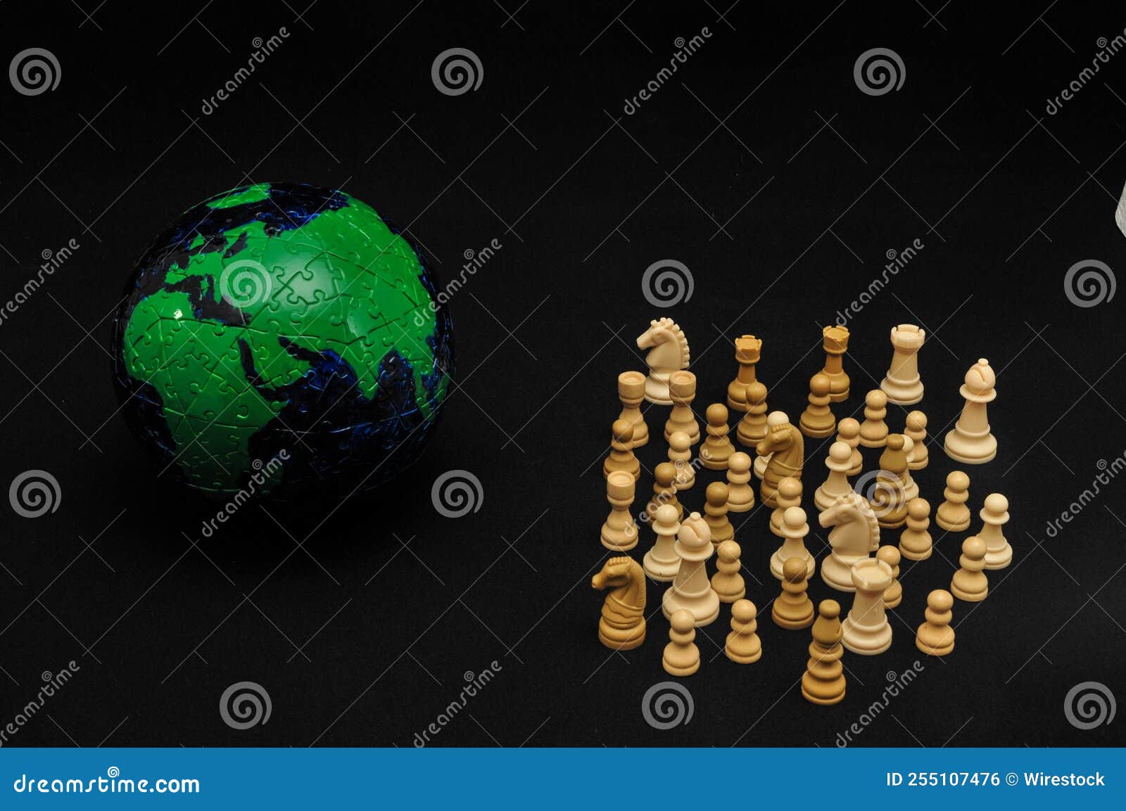 Globe Puzzle and White Chess Pieces Isolated on a Black Background ...