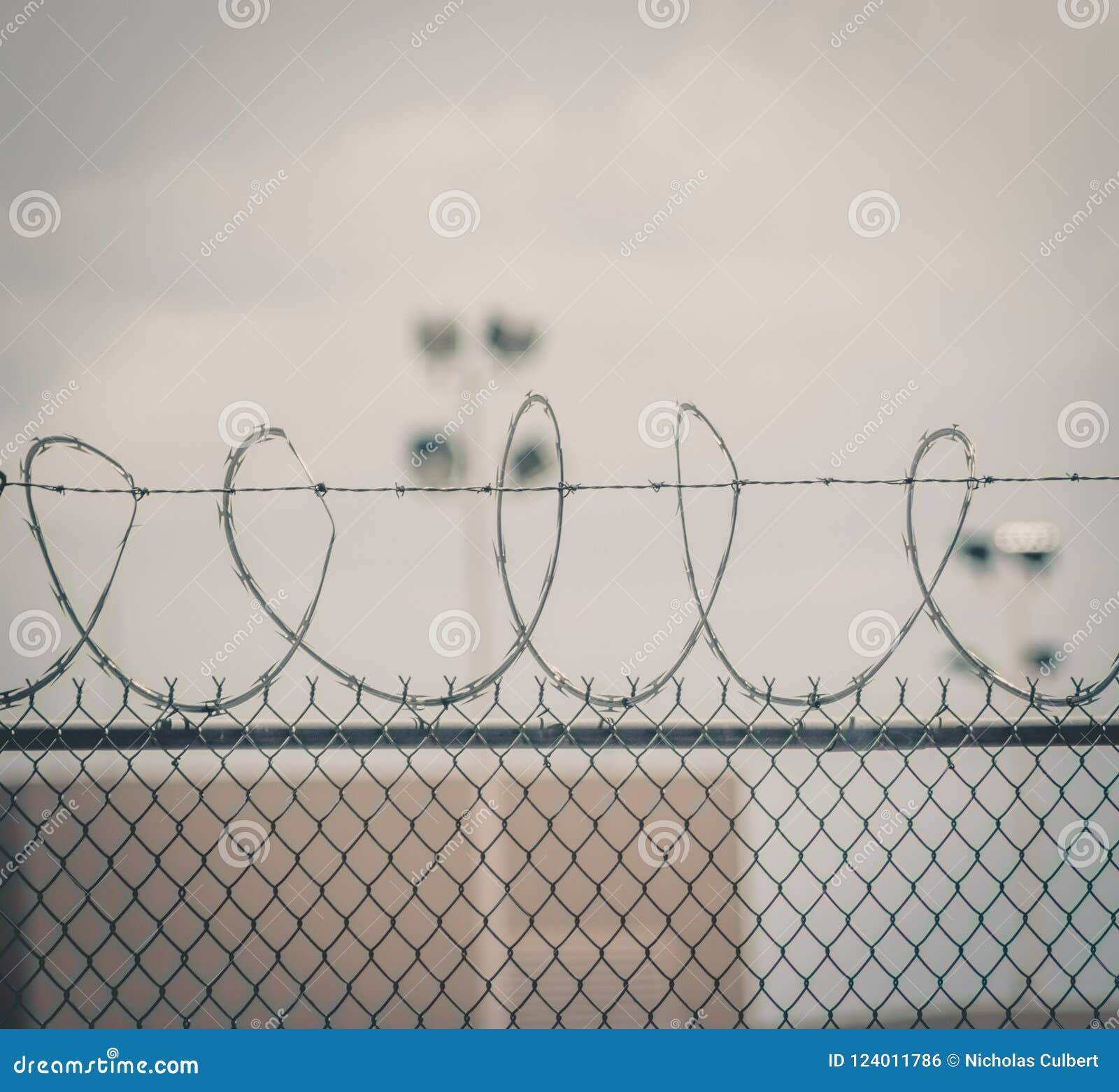Gloomy prison barbed wire stock photo. Image of security - 124011786