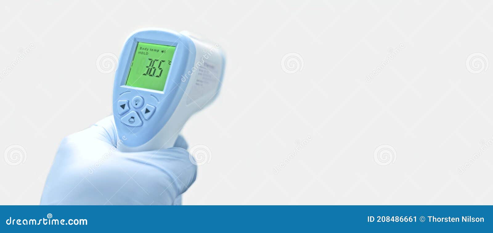 Gloved Hand Holding a Digital Body Temperature Detection Device. Stock ...