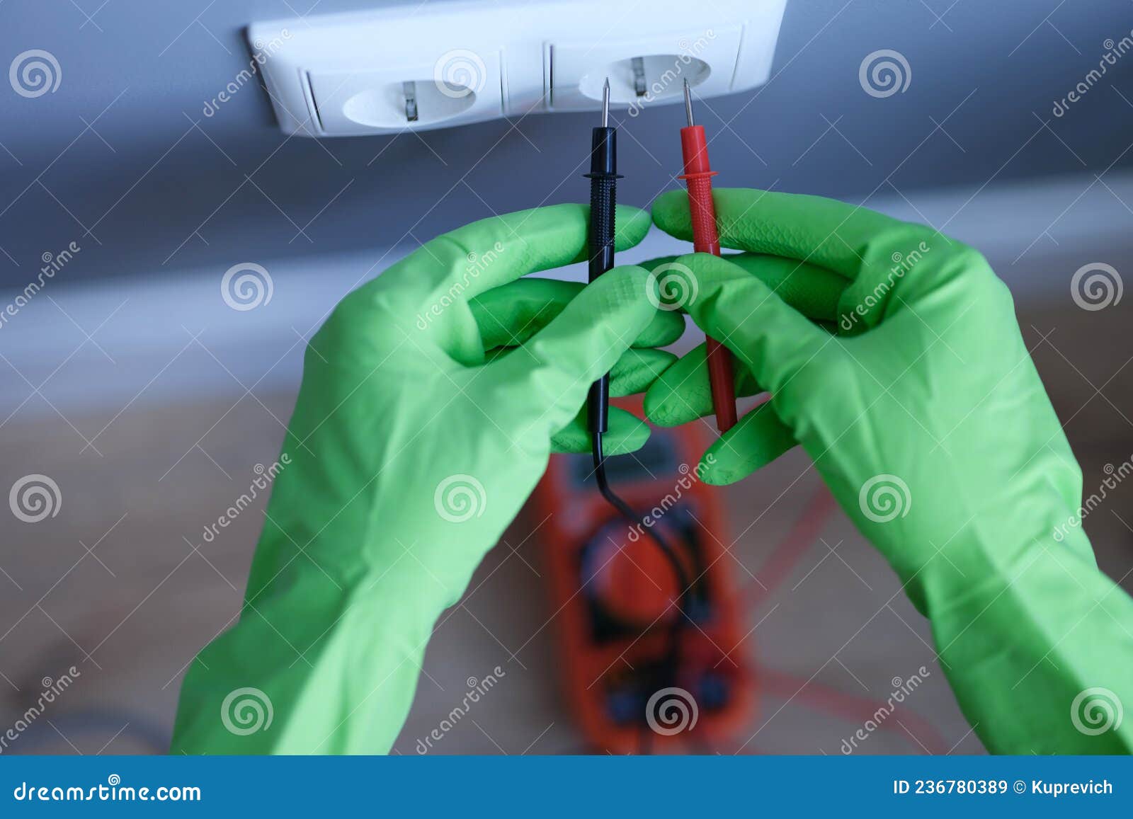 Gloved Hands are Holding a Digital Multimeter Near the Socket Stock ...