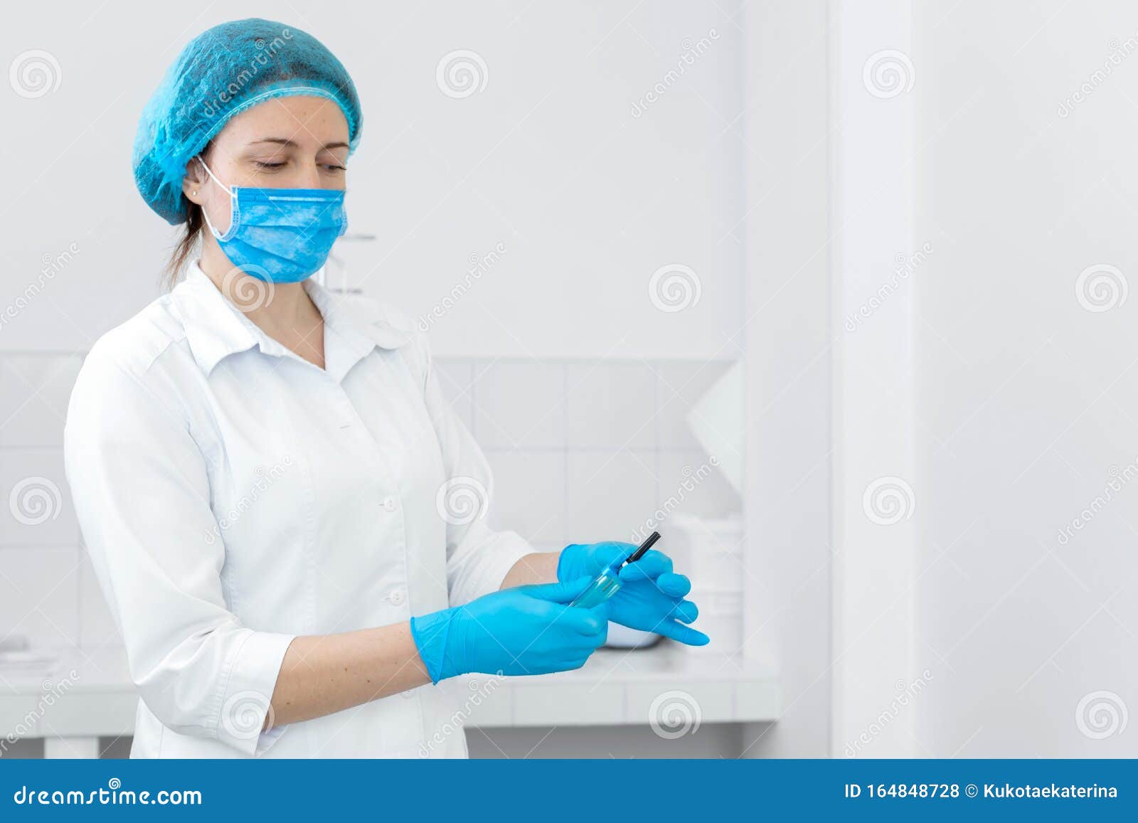 A Gloved Nurse Inserts A Needle Into A Vein On The Patients Arm And ...