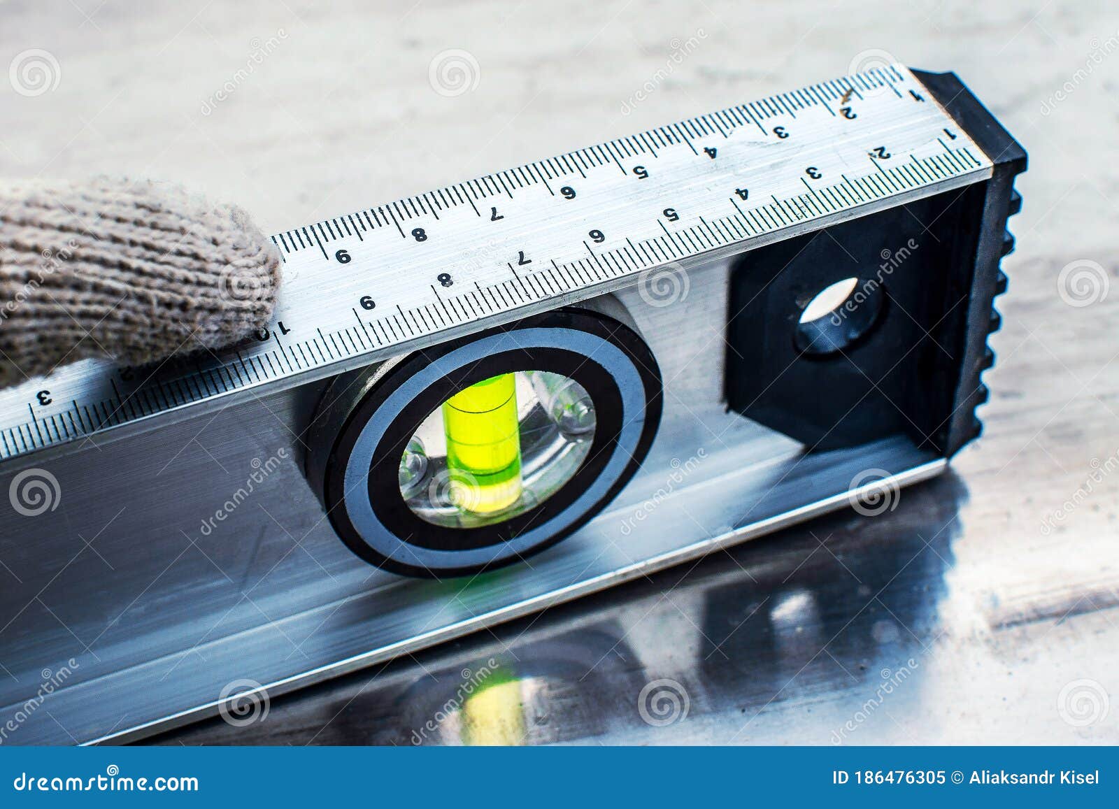 A Gloved Worker Measures the Iron Surface with a Spirit Ruler. Close-up ...
