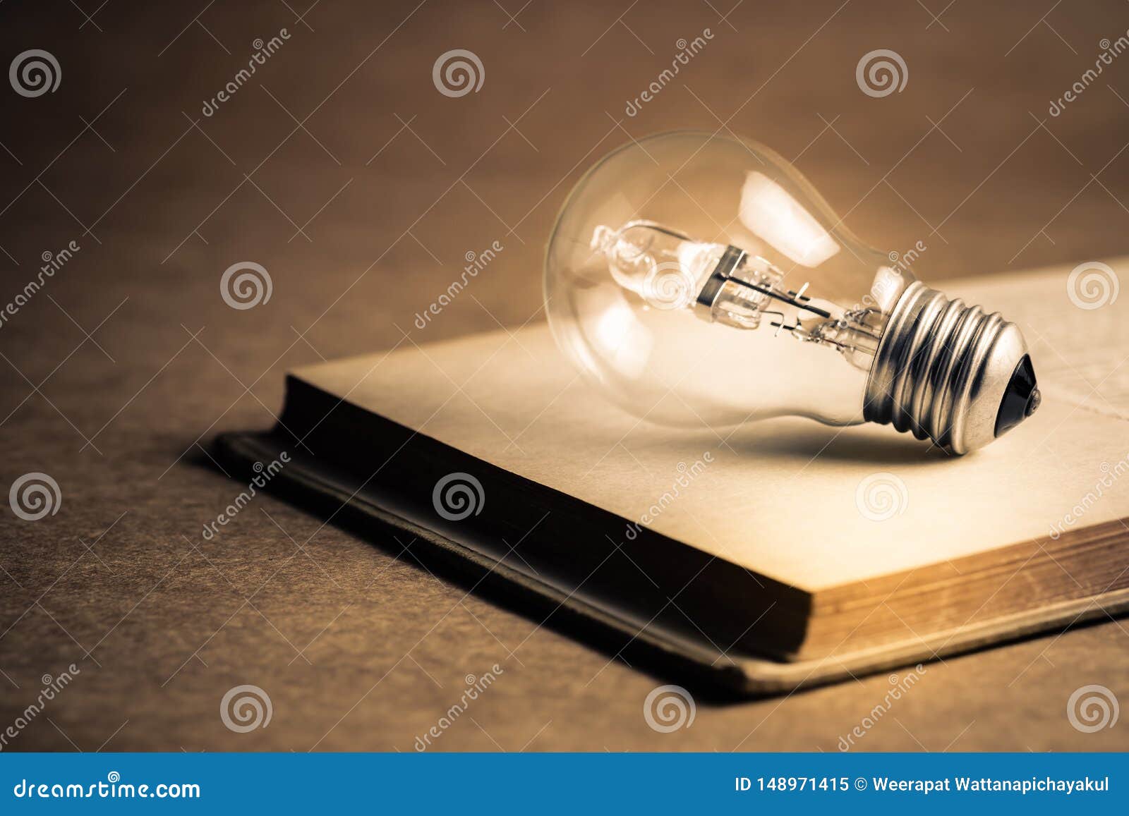 Glowing Bulb and Old Books stock image. Image of concept - 148971415