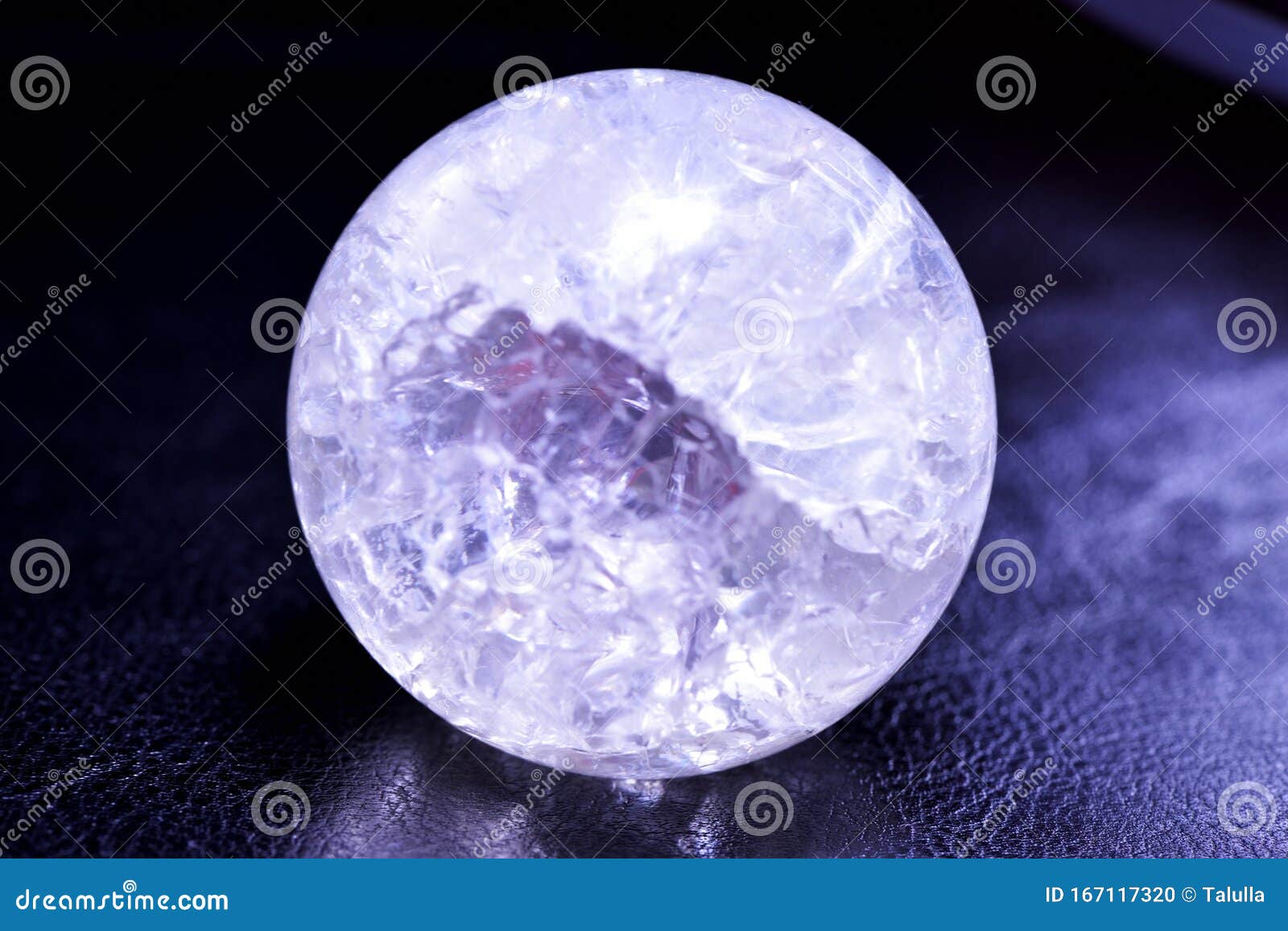 Glowing Crystal Ball with Cracks Inside on a Dark Background. the ...