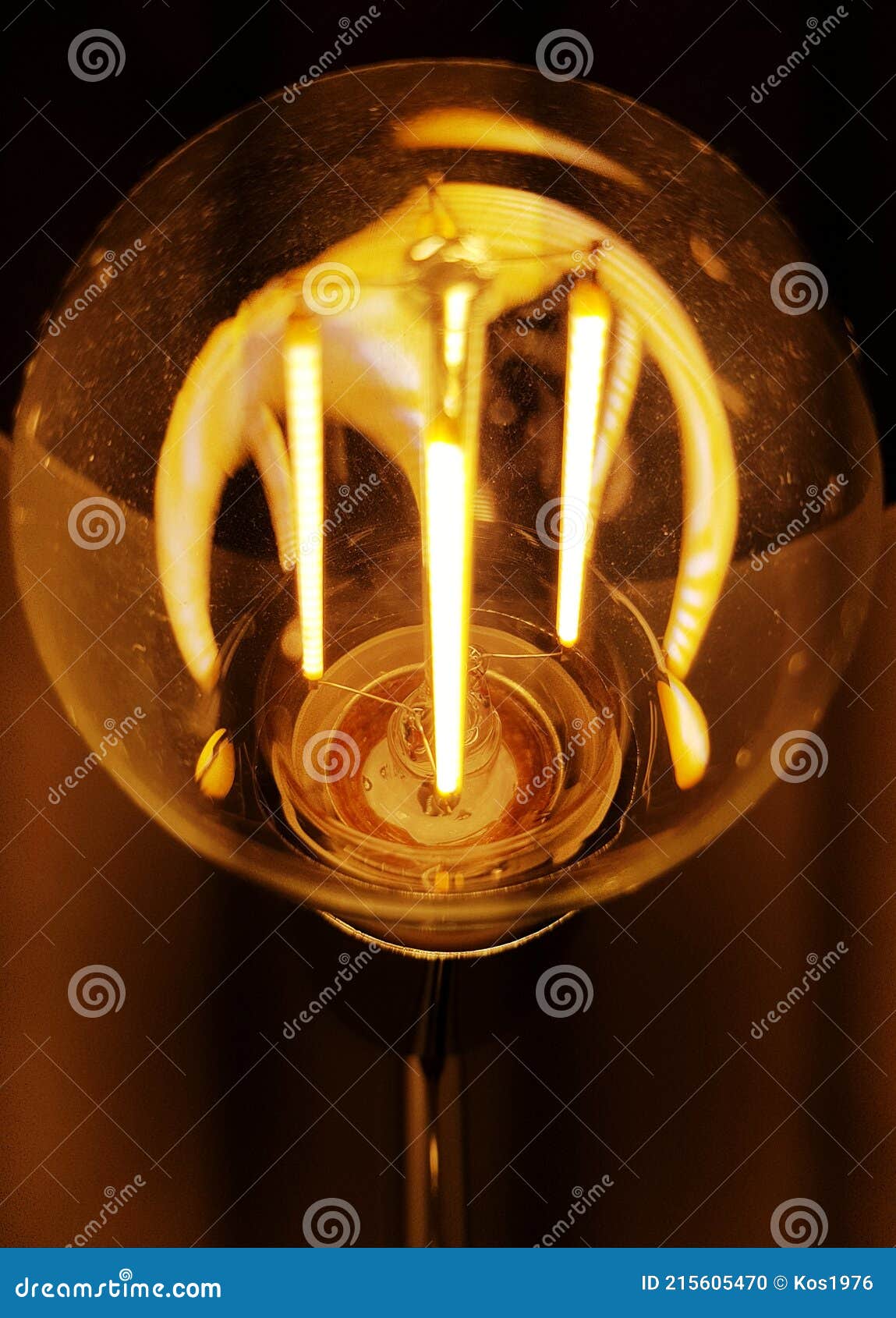 Glowing Filament in a Light Bulb Stock Photo - Image of golden ...