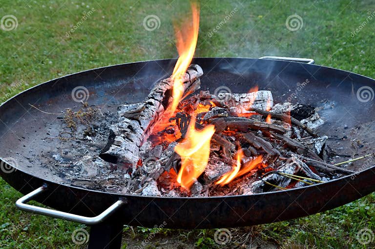 Glowing fire on disc grill stock image. Image of burn - 259700651