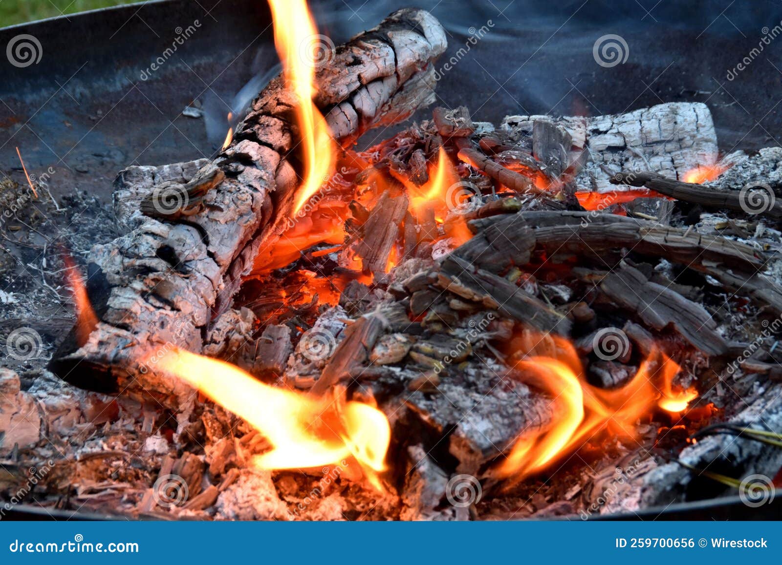 Glowing fire on disc grill stock photo. Image of illumination - 259700656