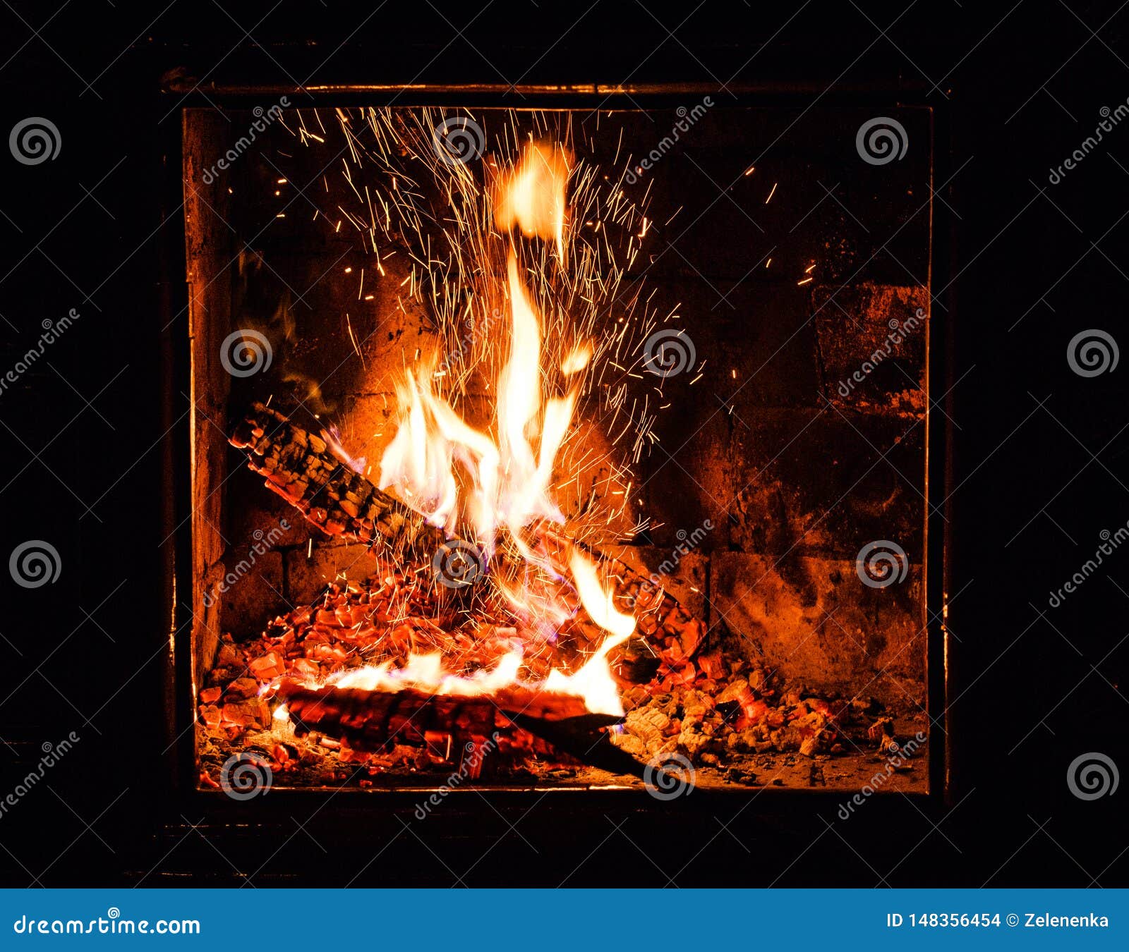 Glowing fire in fireplace stock photo. Image of yellow - 148356454