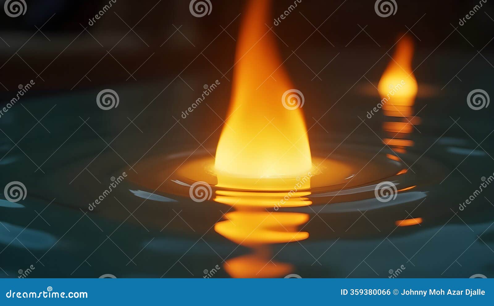 A Glowing Flame Floating on a Calm Water Surface with Reflections Stock ...