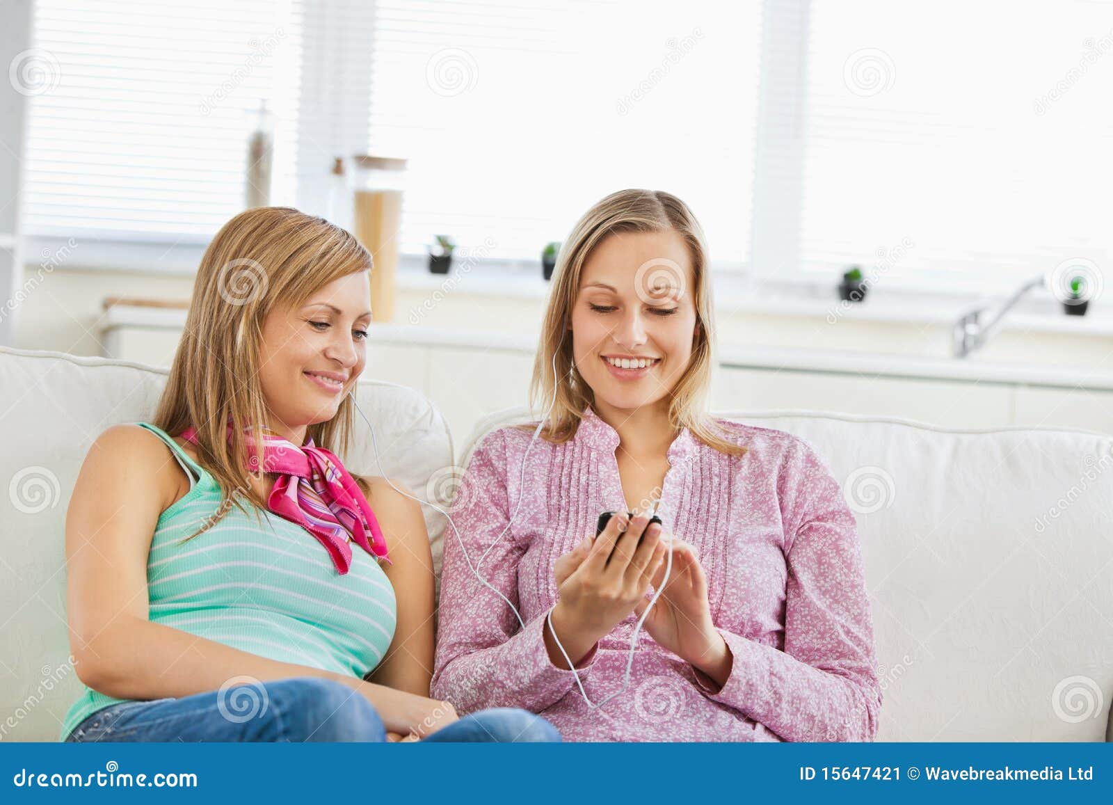 Glowing Friends Listen To Music Using a Cellphone Stock Image - Image ...