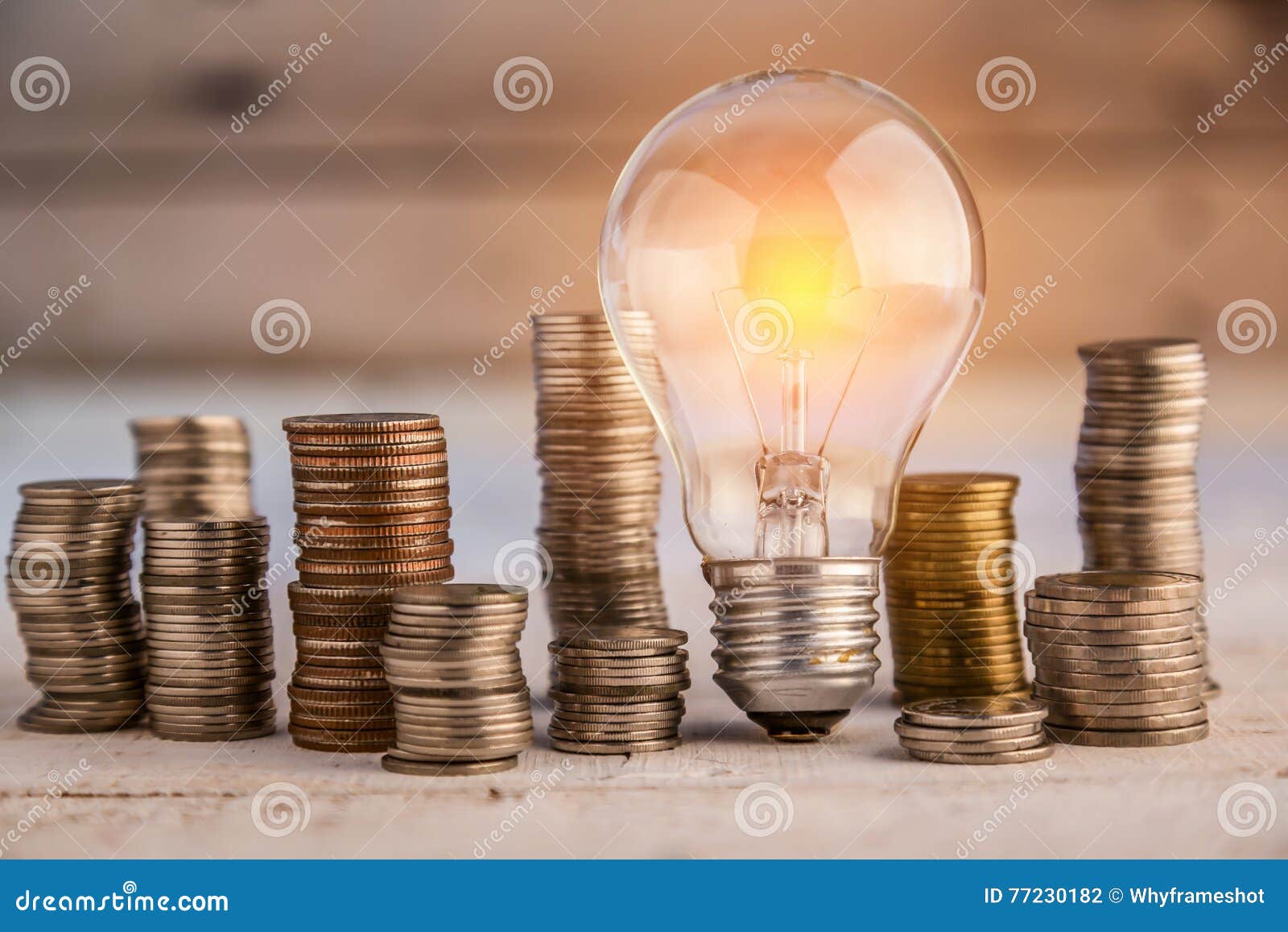 Glowing Light Bulb among Many Coins Stock Photo - Image of financial ...