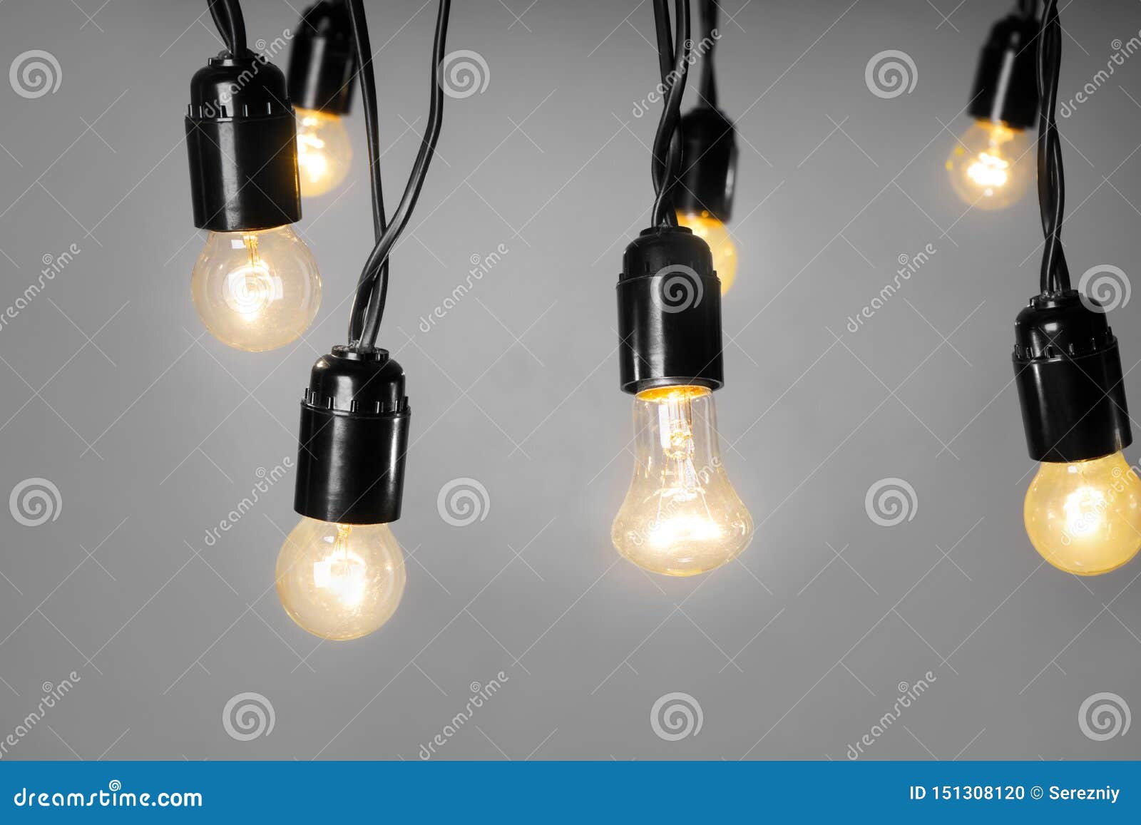 Glowing Light Bulbs on Grey Background Stock Photo - Image of lightbulb ...