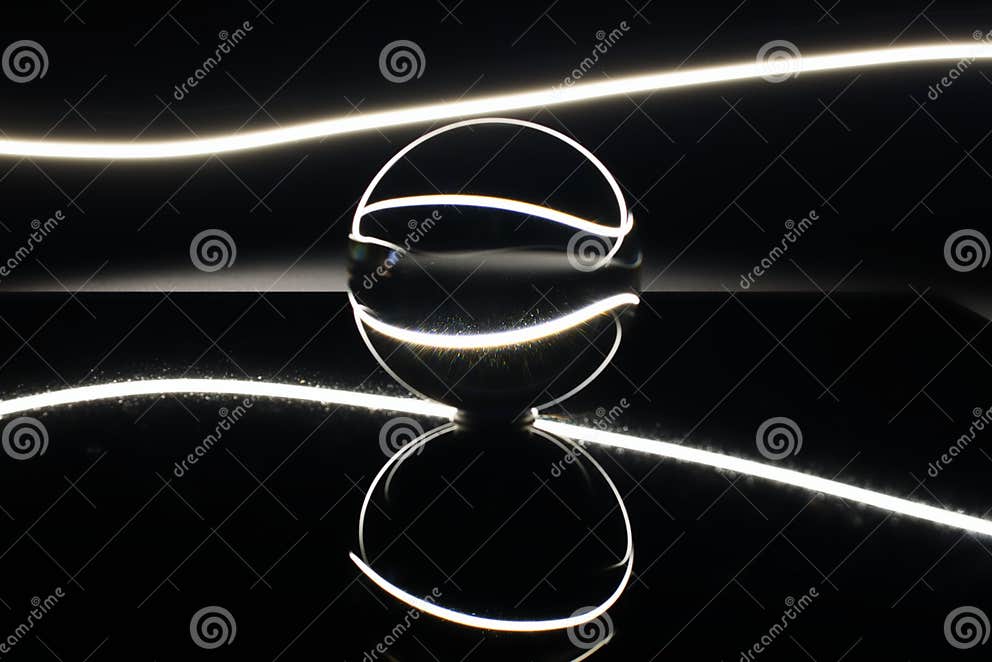 A Sphere Illuminated by Light in the Dark with Its Reflection Stock ...