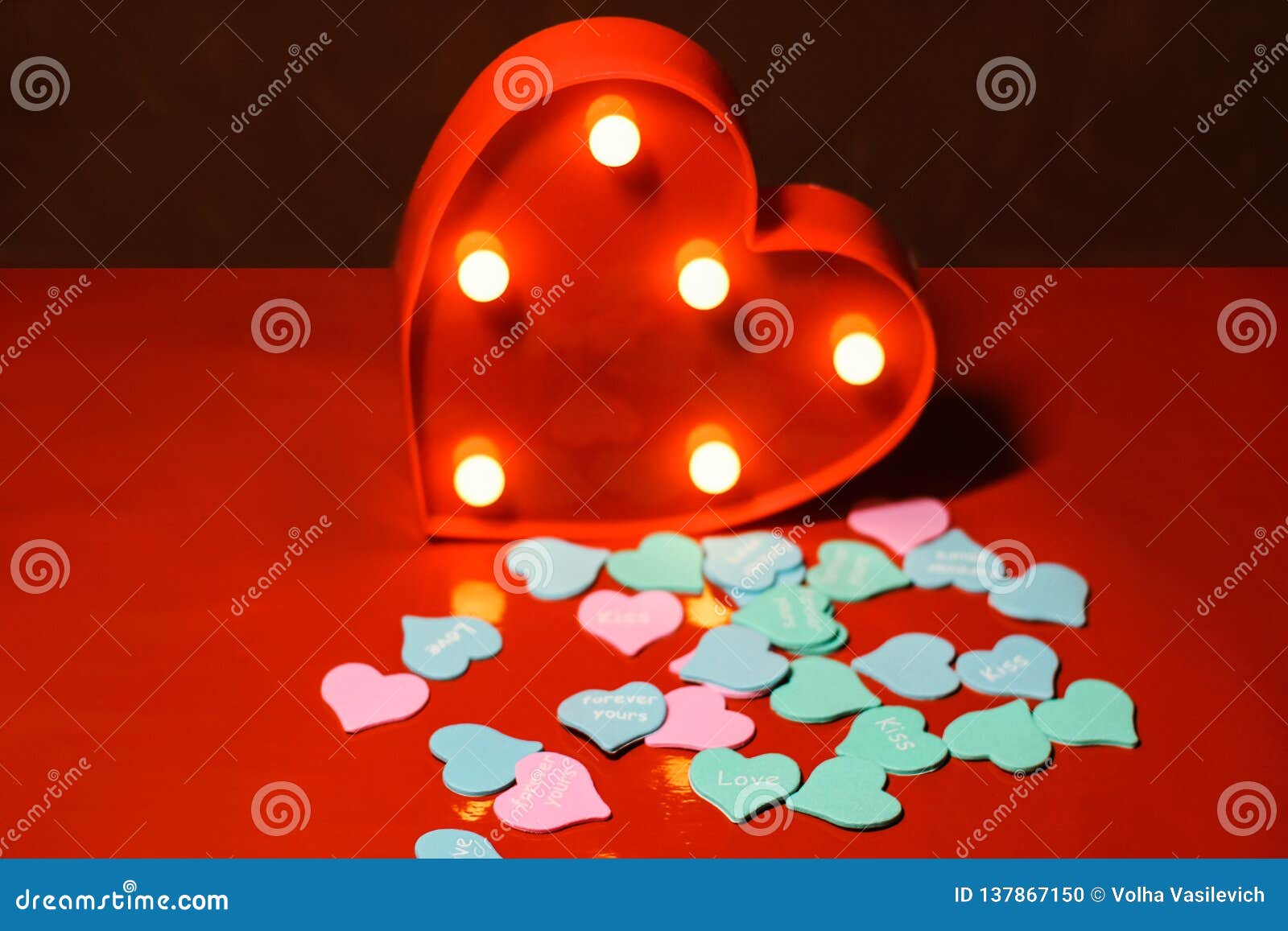 Glowing Red Heart with Flashlights on the Red Background Closeup Stock ...