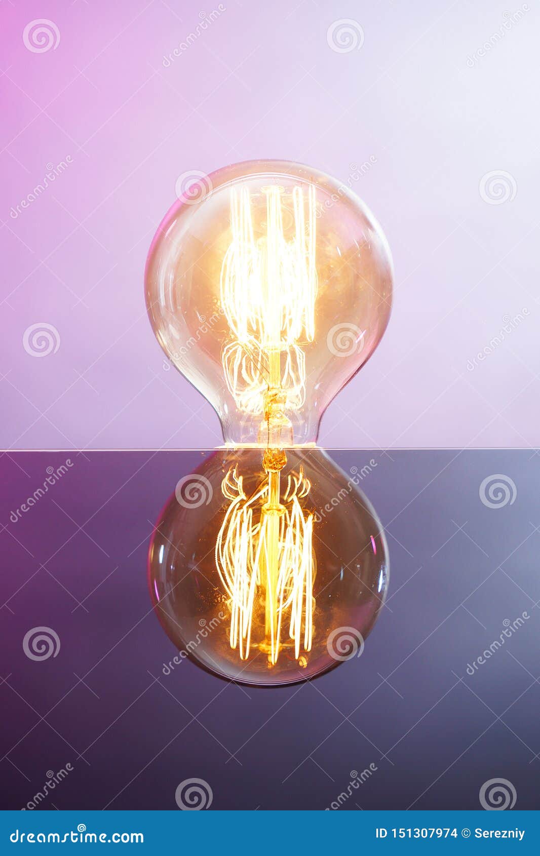 Glowing Retro Light Bulb with Reflection on Color Background Stock ...