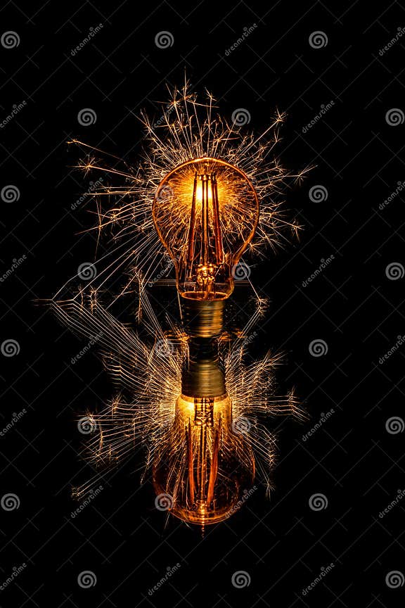 Glowing Sparkler Behind a Retro Light Bulb Stock Photo - Image of bulb ...