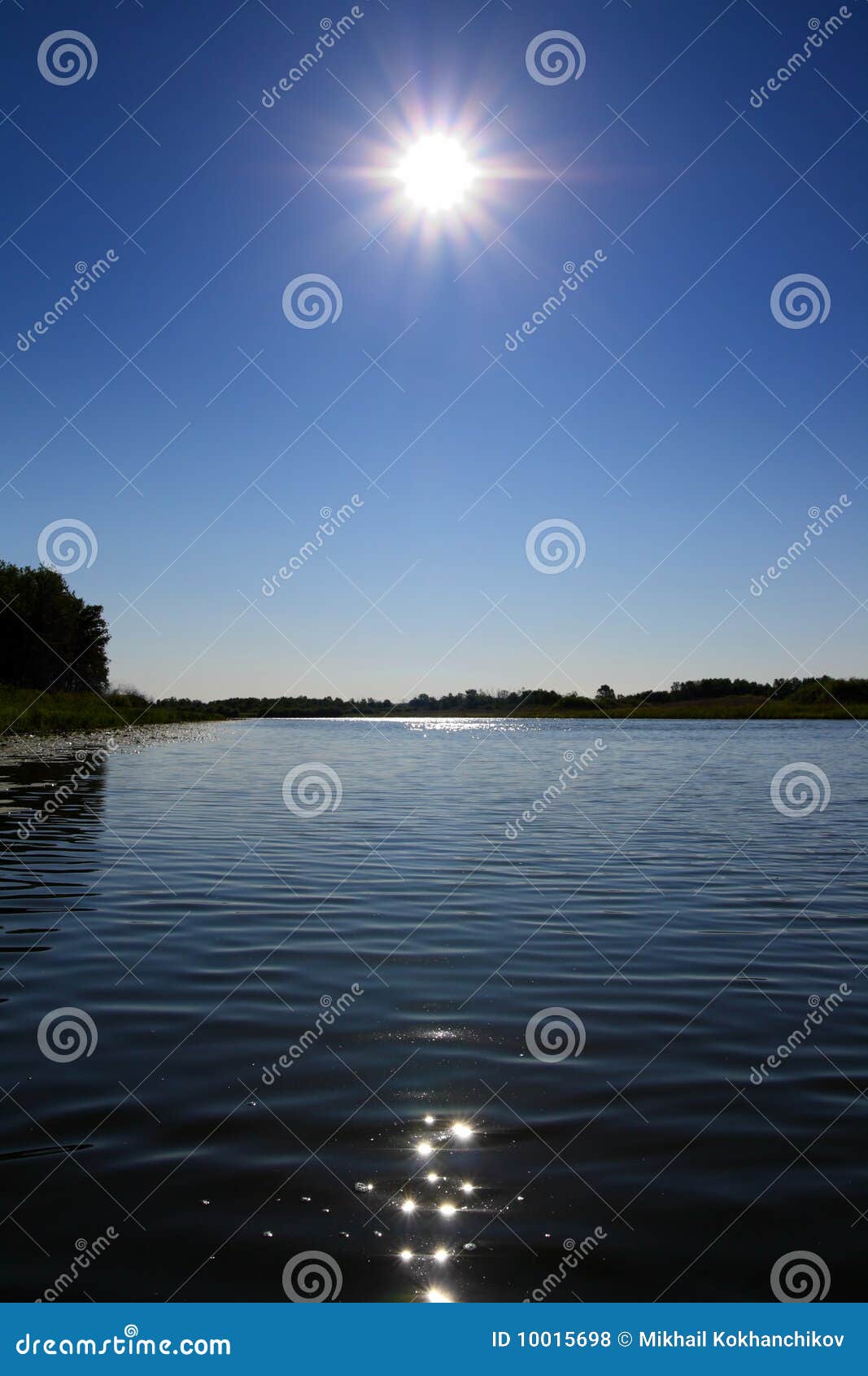 Glowing sun over lake stock photo. Image of landscape - 10015698