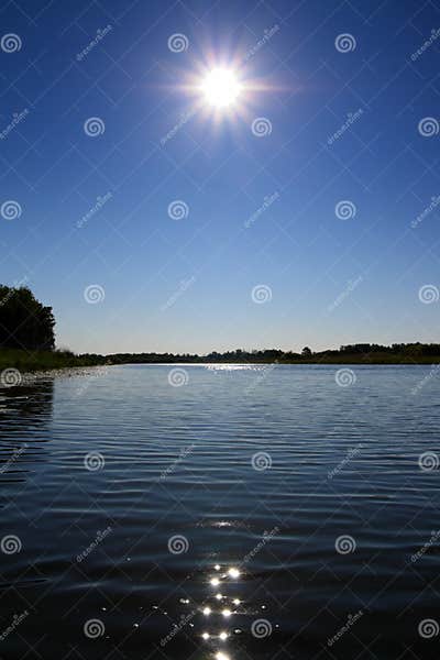 Glowing sun over lake stock photo. Image of landscape - 10015698