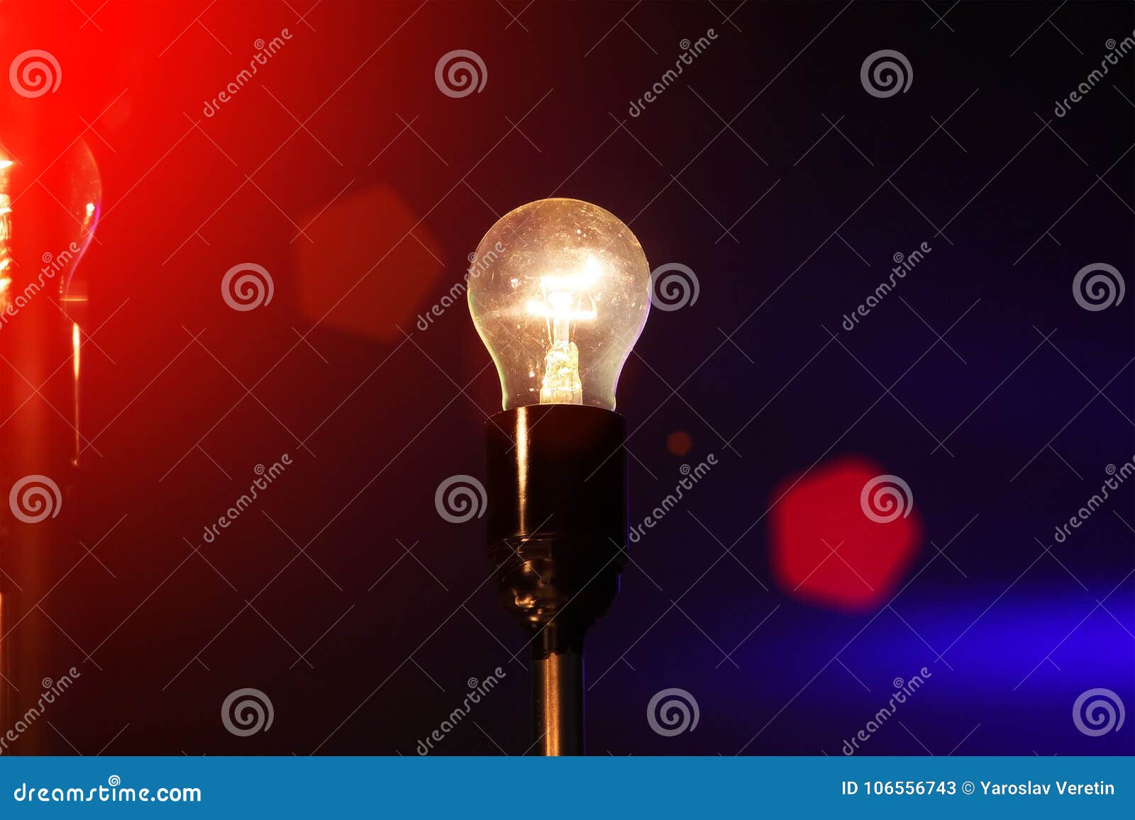 Glowing Light Bulb Against Blue and Red Wall Background Stock Image ...