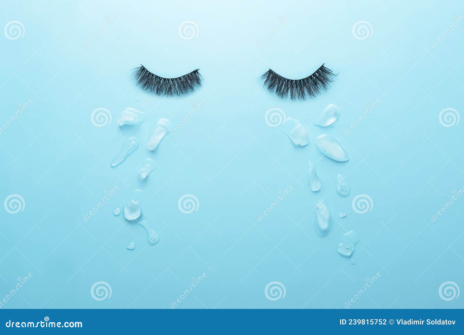 Glued Lashes on a Blue Background with Tears in the Form of Ice Pieces ...