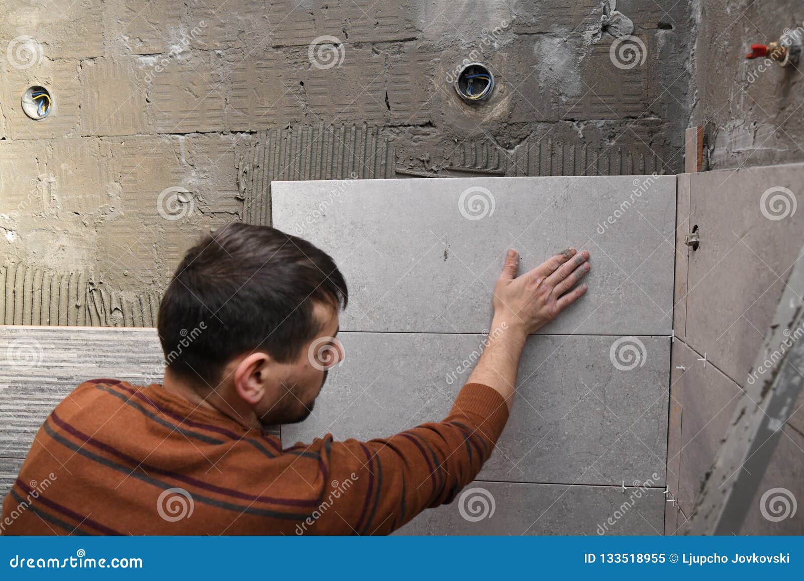 Gluing Tiles on the Wall. Laying Tiles on the Wall Stock Image - Image ...