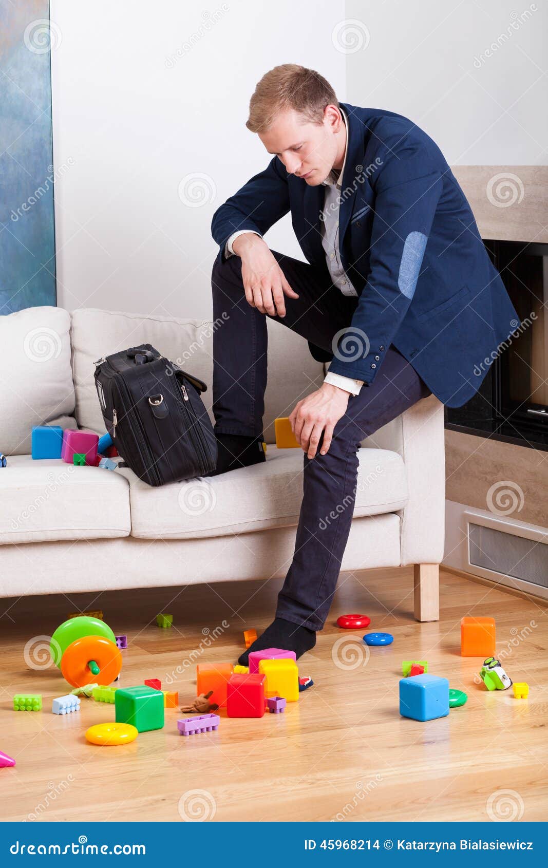 Glum man sitting on sofa stock photo. Image of babysitting - 45968214