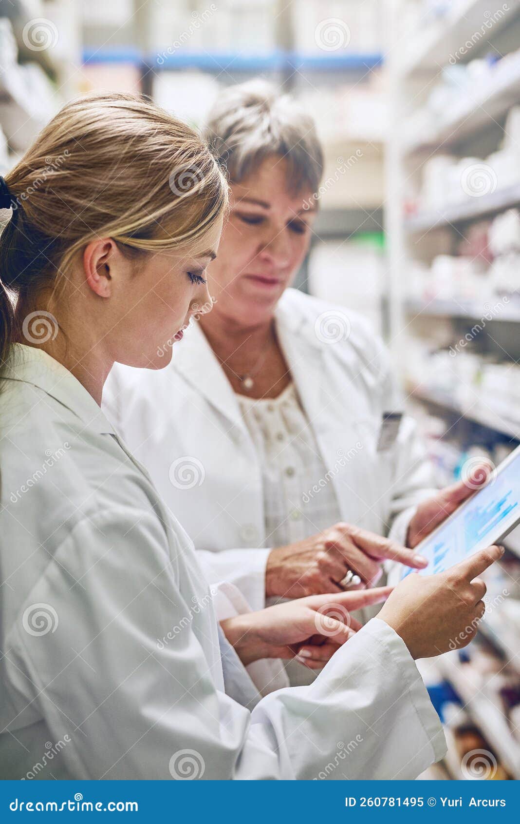 They Go the Extra Mile. Pharmacists Using a Digital Tablet Together ...