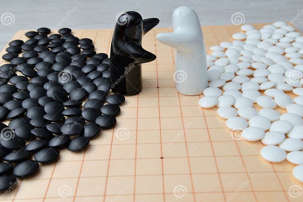 Go Game Pieces and Two Black and White Figures Stock Image - Image of ...