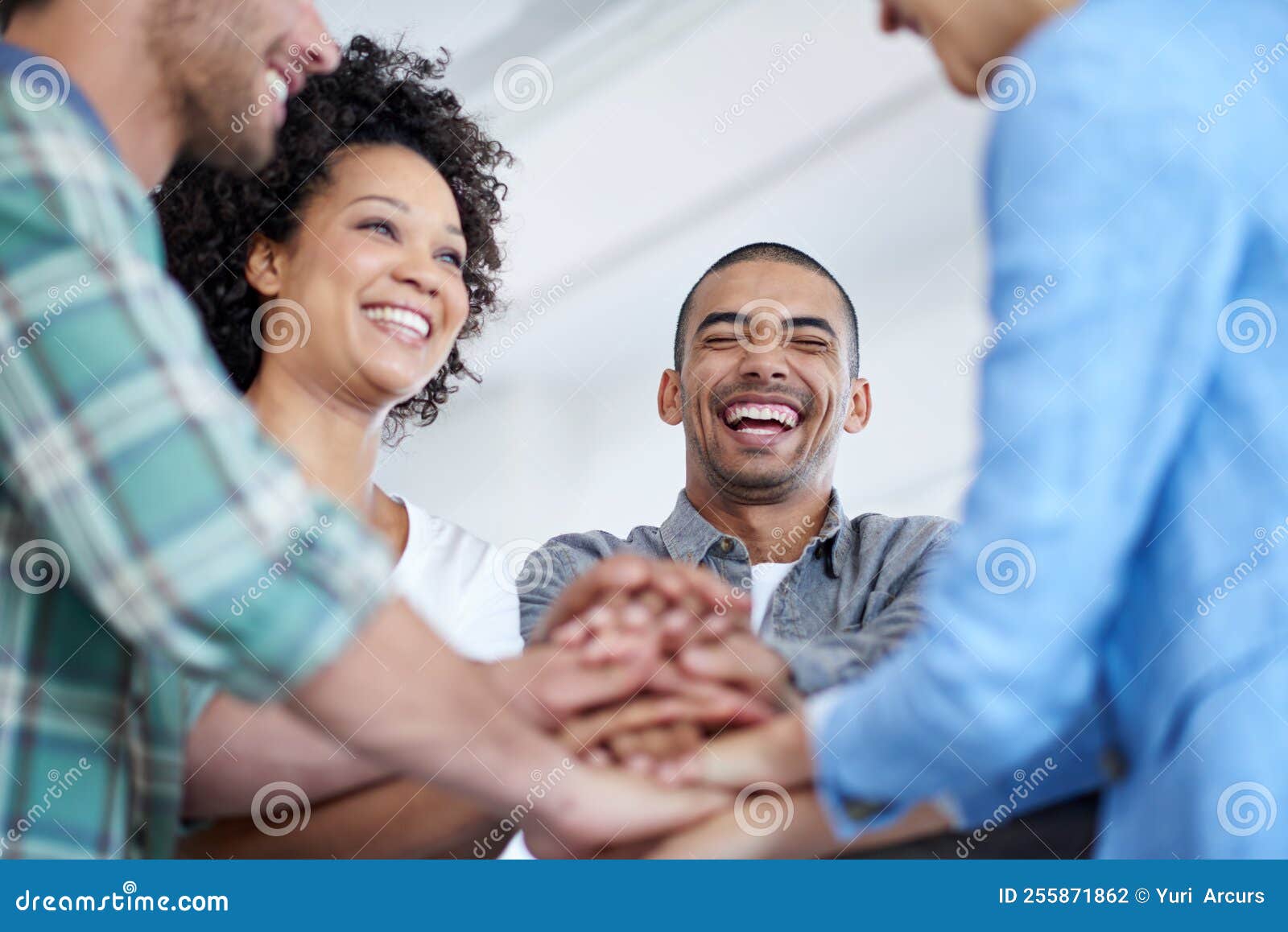 Go Team. a Smiling Group of Coworkers Standing in a Huddle in an Office ...