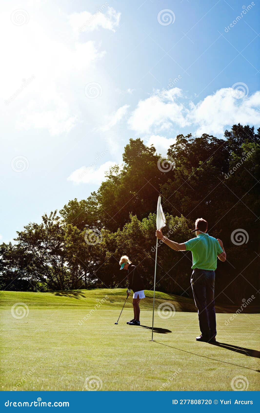The Goal is the Hole. a Couple Playing Golf Together on a Fairway ...