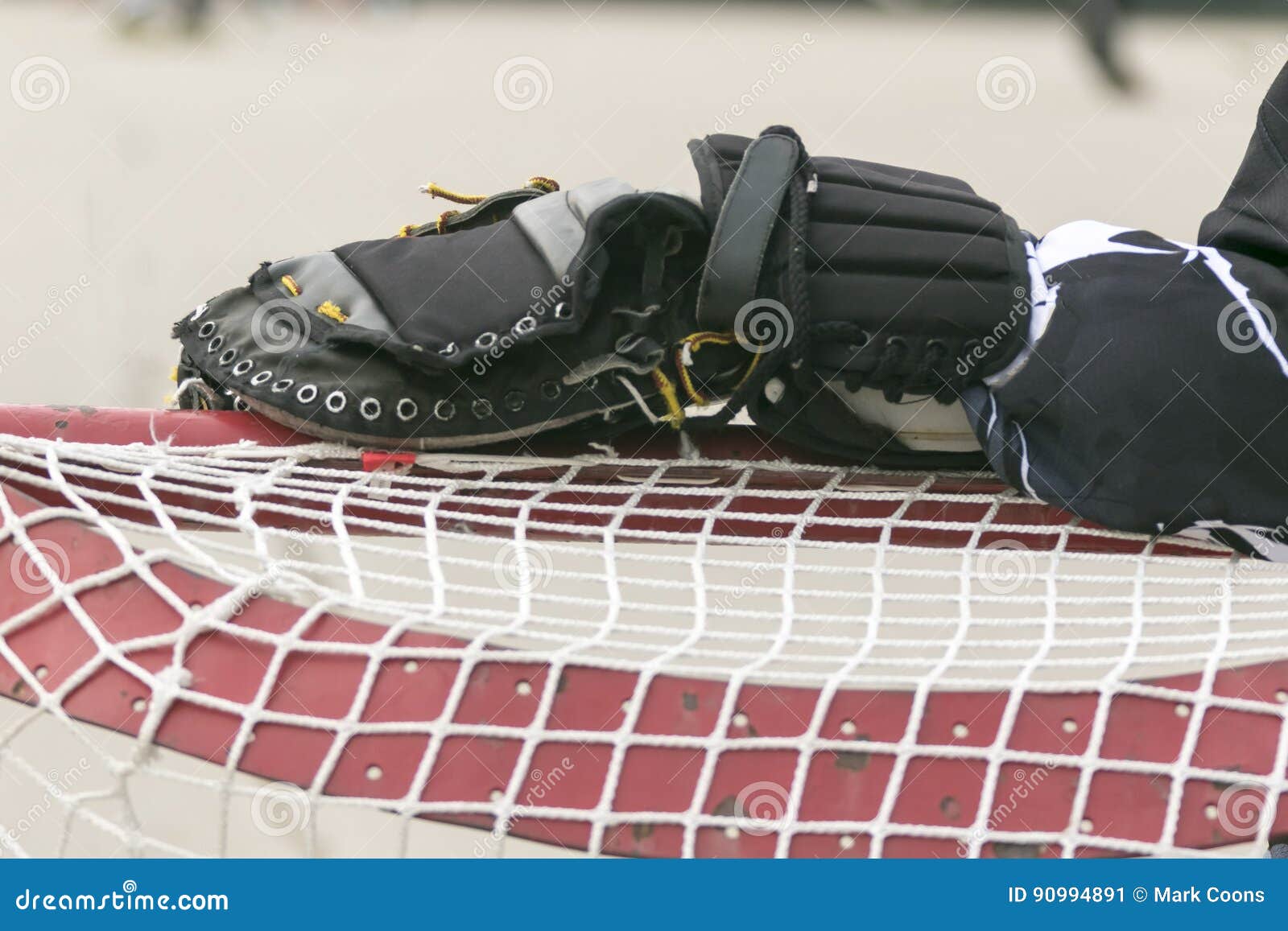 Goalie Resting His Glove Hand on the Net between Plays Stock Image ...