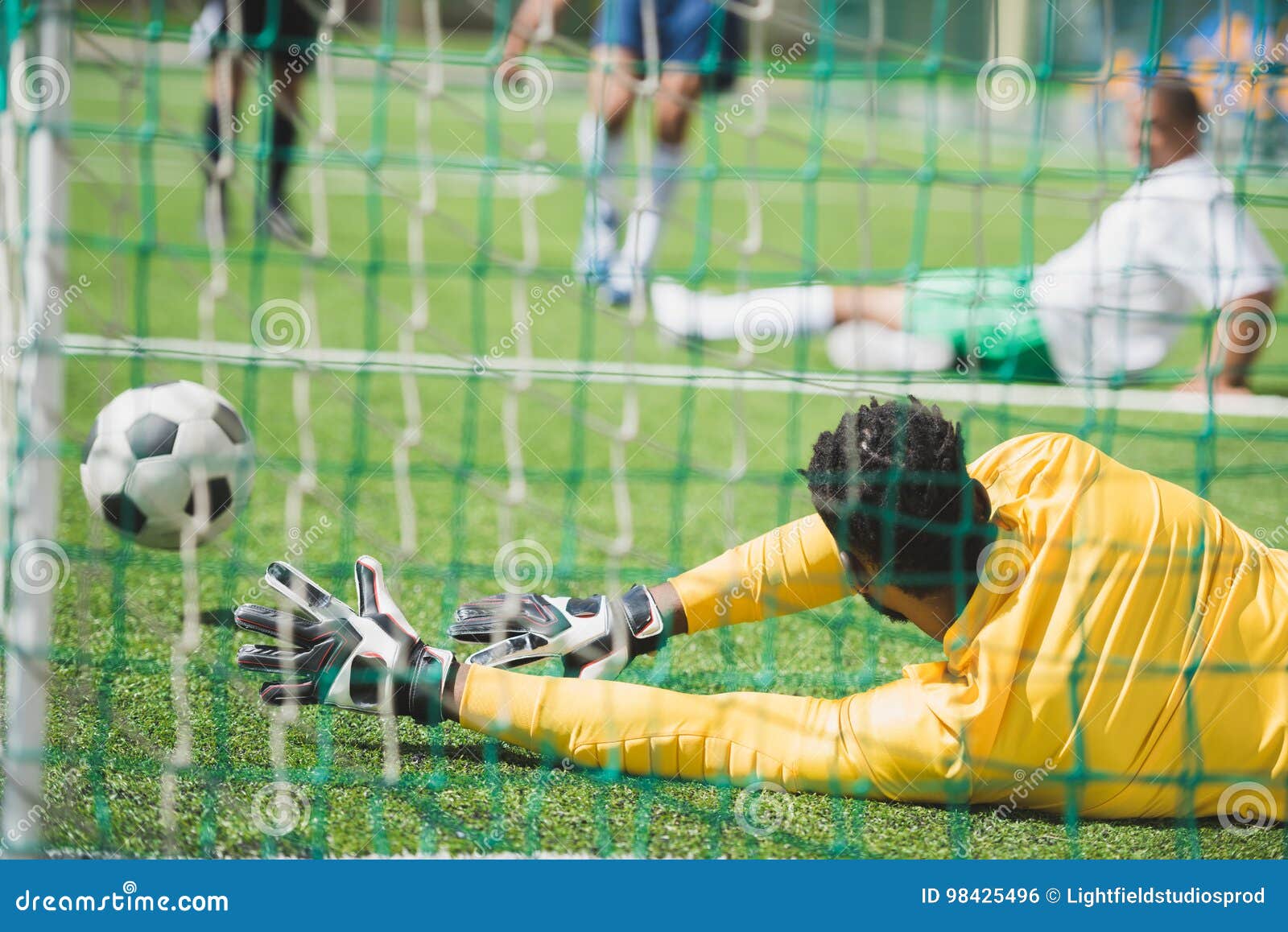 Goalkeeper Catching Ball during Soccer Match on Pitch Stock Photo ...