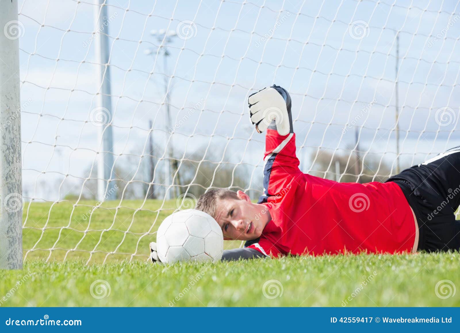 Goalkeeper in Red Making a Save Stock Image - Image of sportsman ...