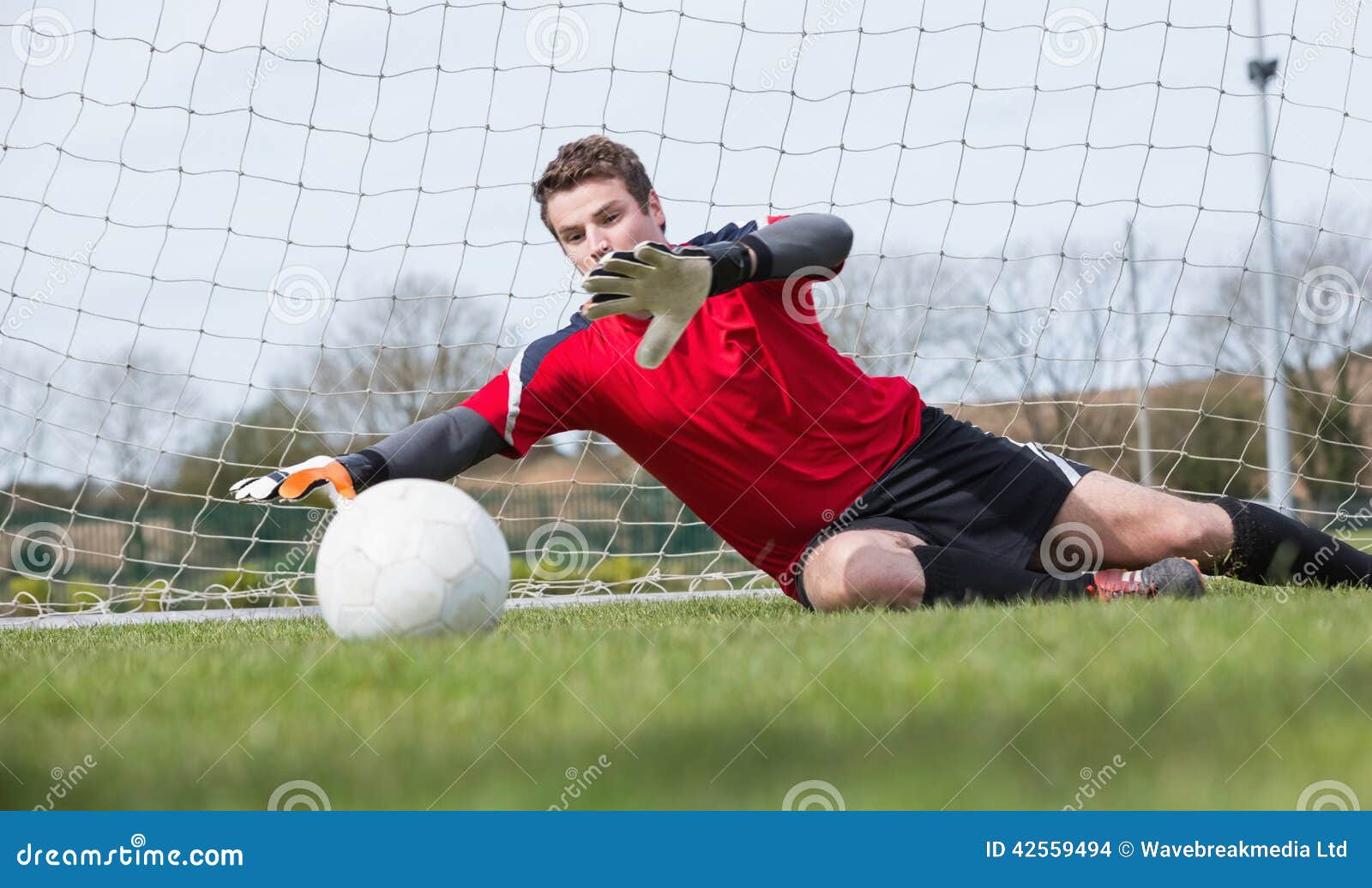 Goalkeeper in Red Saving a Goal during a Game Stock Photo - Image of ...