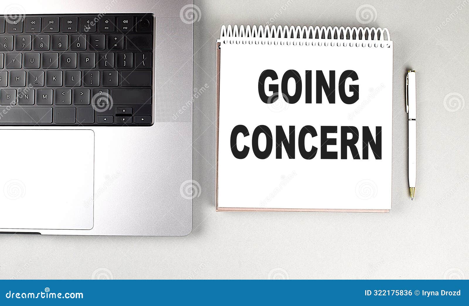 GOING CONCERN Text on Notebook with Laptop and Pen Stock Photo - Image ...