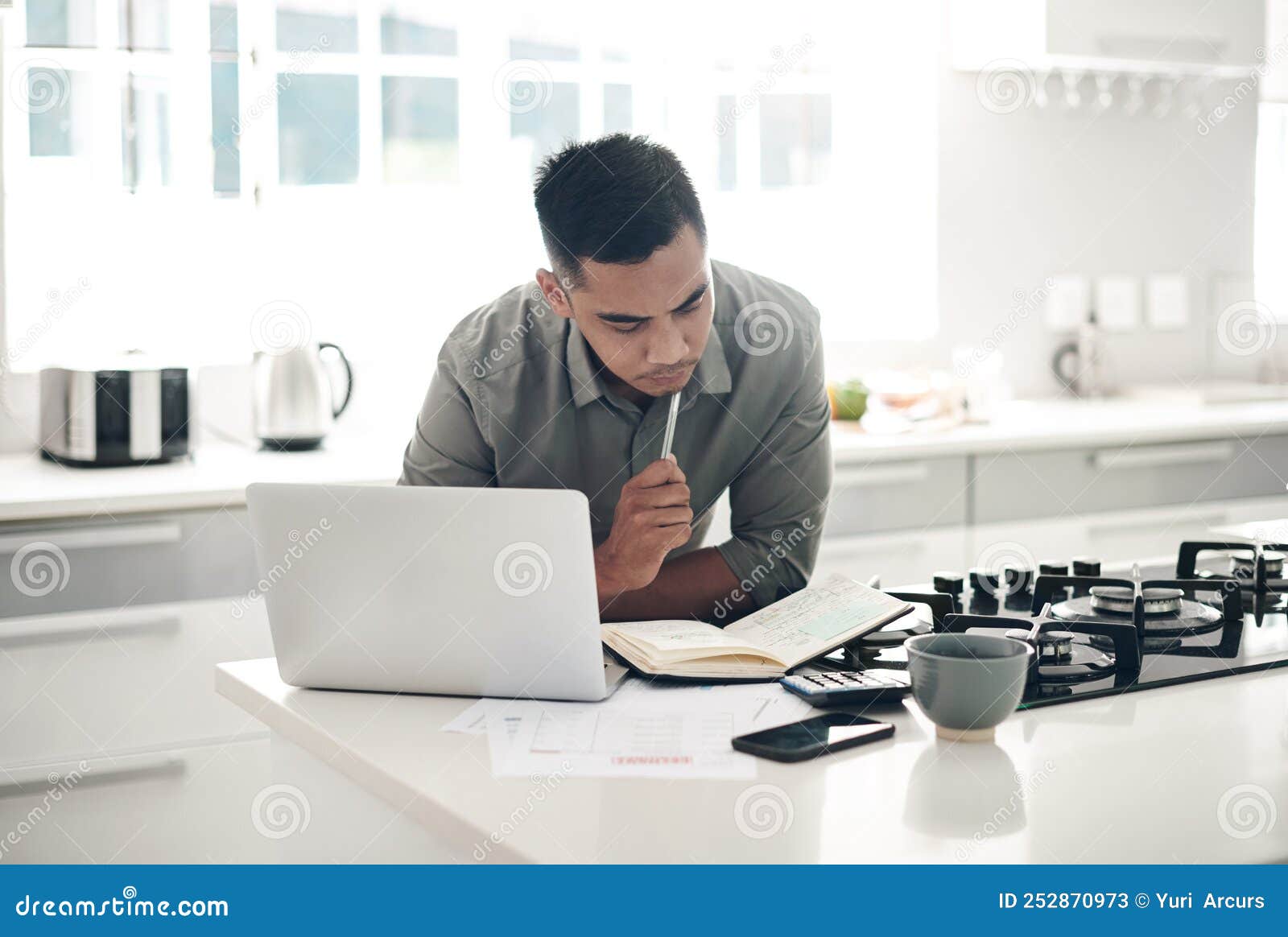 Going through His Notes Very Carefully. a Young Man Using a Laptop ...