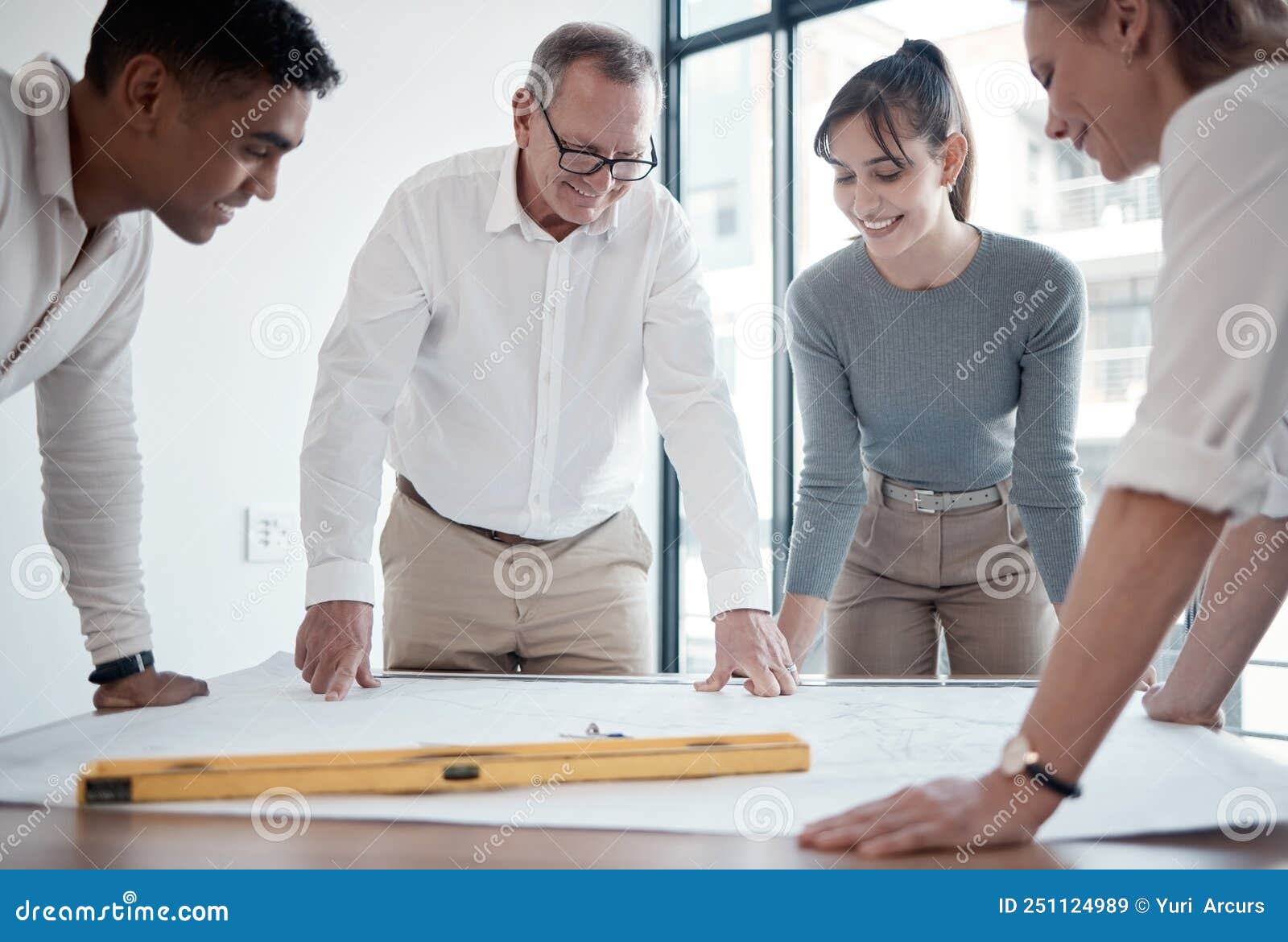 Going Over the Blueprints. Cropped Shot of Four Architects Looking Over ...