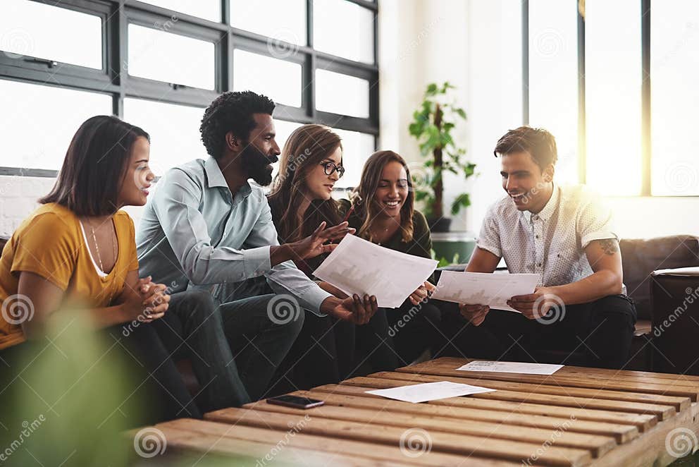 Going Over the Draft. a Group of Young Designers Having a Meeting in a ...