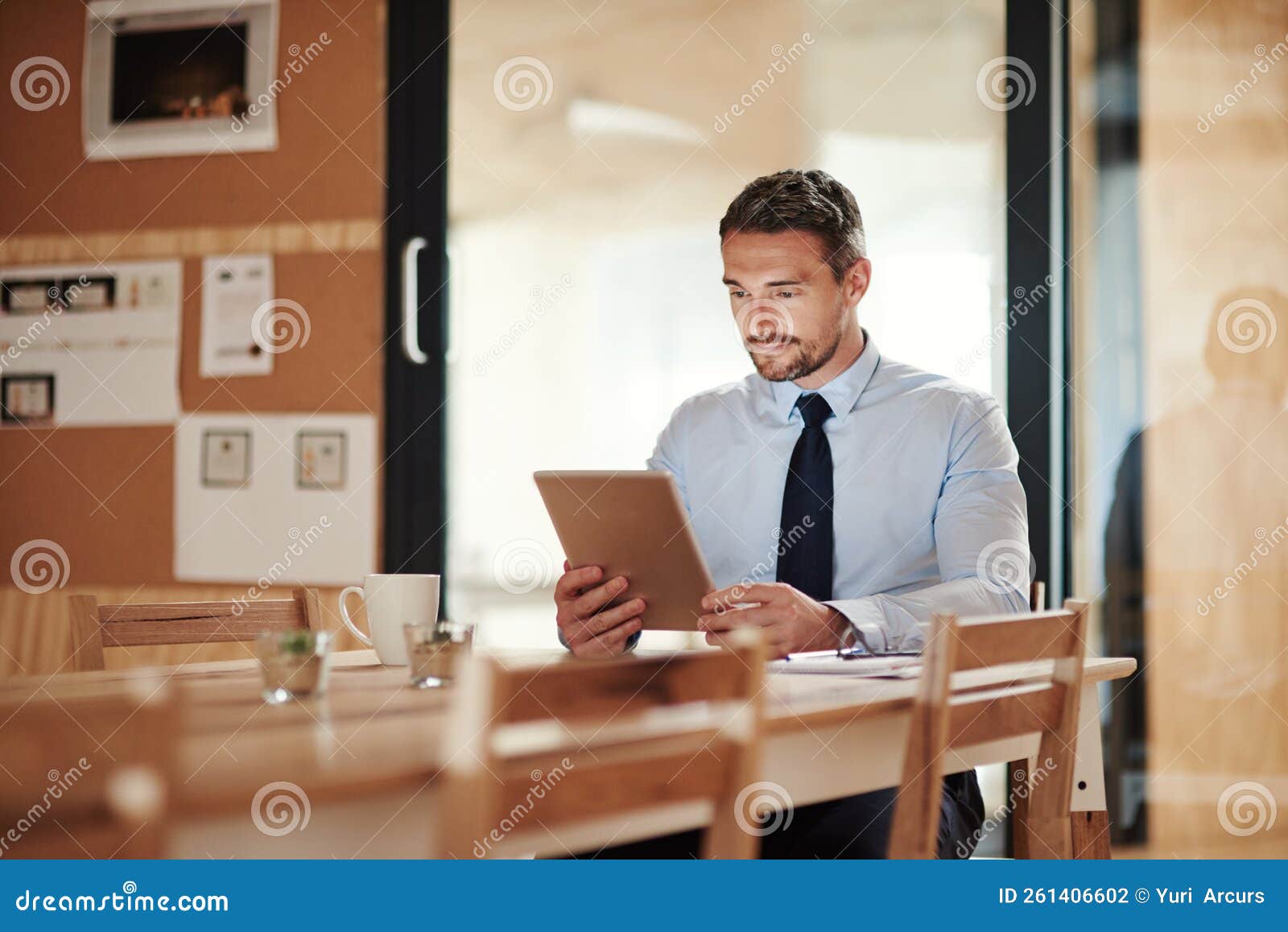 Going Over His Digital Paperwork. a Businessman Using a Digital Tablet ...