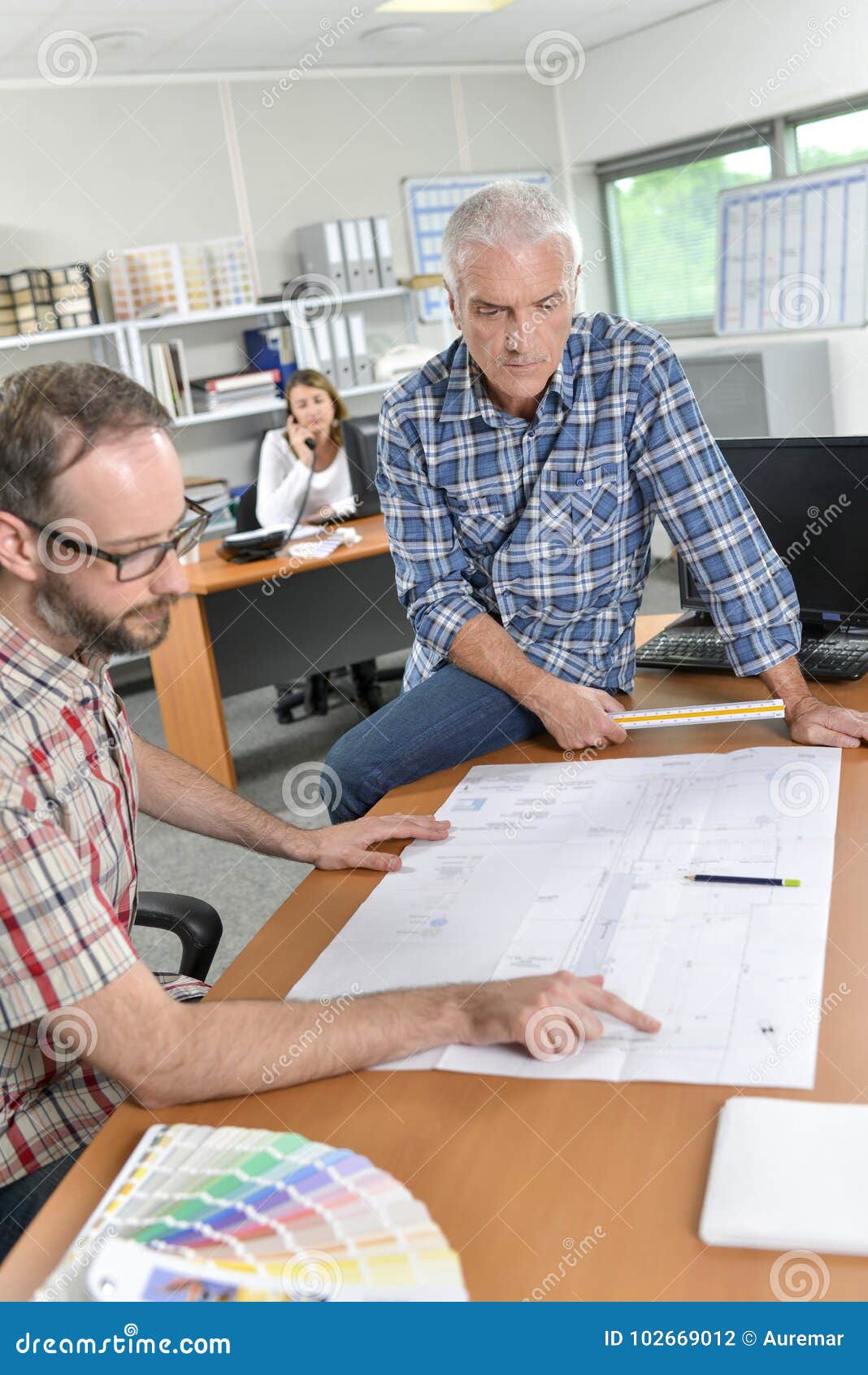 Going over plans together stock photo. Image of paper - 102669012