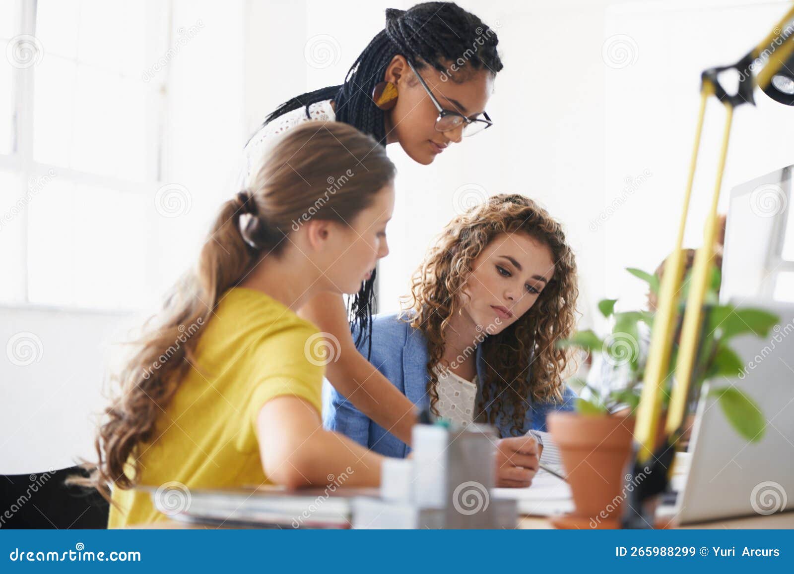 Going Over Their Work with a Fine Tooth Comb. Young Female Coworkers ...