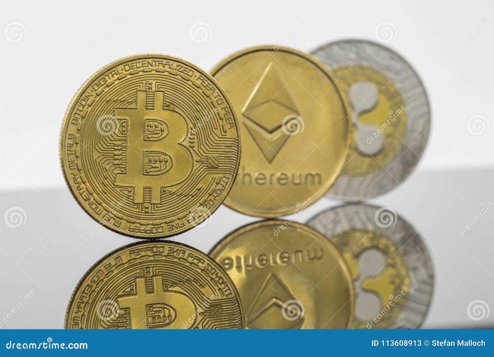 Gold Bitcoin, Etherium and Ripple Tokens in a Row Editorial Stock Photo ...