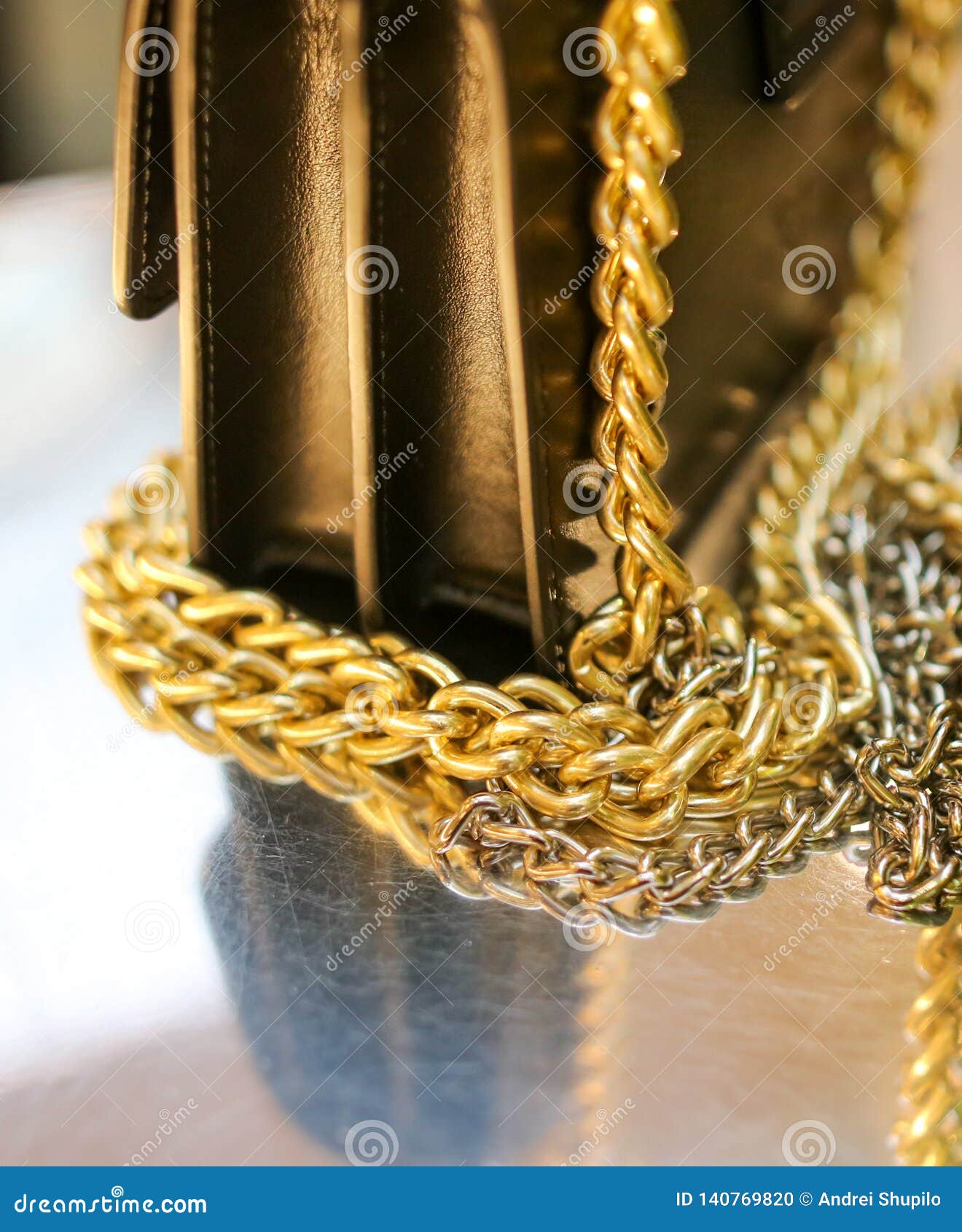 Gold chain on the bag stock photo. Image of elegant - 140769820