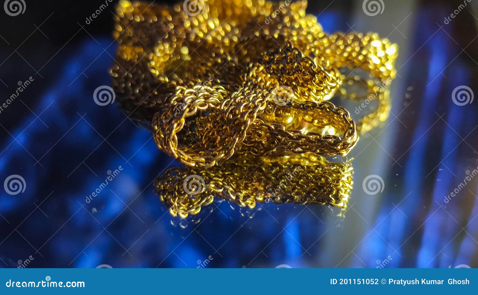 Gold Chain on a Reflective Surface Stock Photo - Image of precious ...