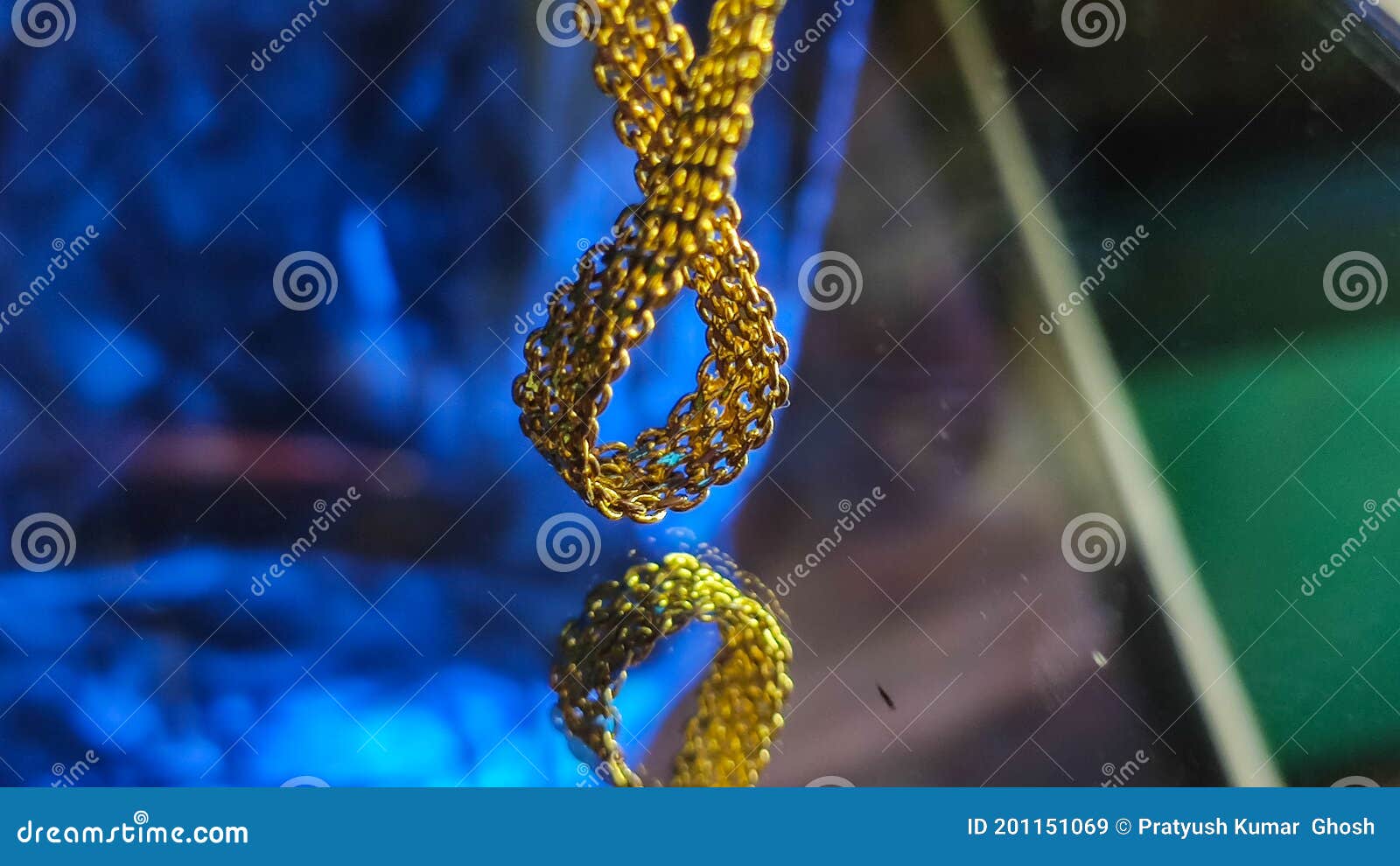 Gold Chain on a Reflective Surface Stock Image - Image of jewelry ...