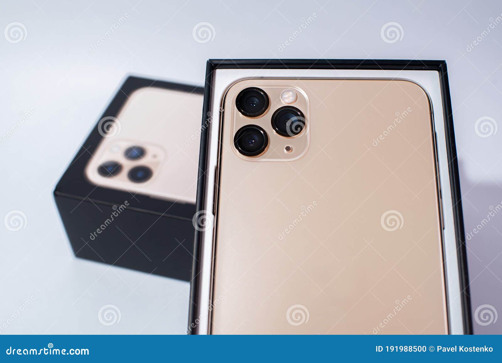 Gold-colored Smartphone with Three Cameras on a White Background. Stock ...