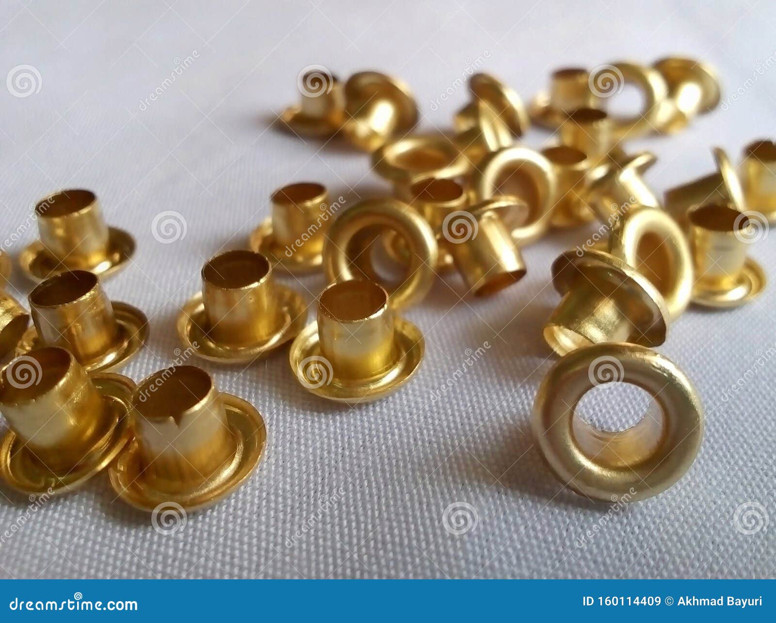 Gold Eyelets on Textured White Cloth Stock Image - Image of isolated ...