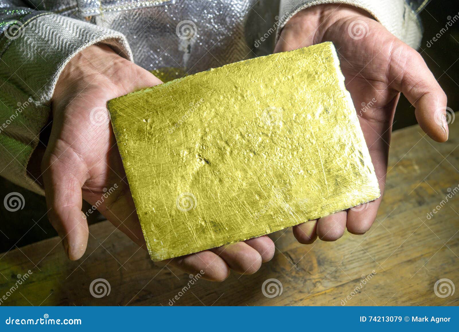 Gold ingot in hands stock image. Image of factory, monetary - 74213079