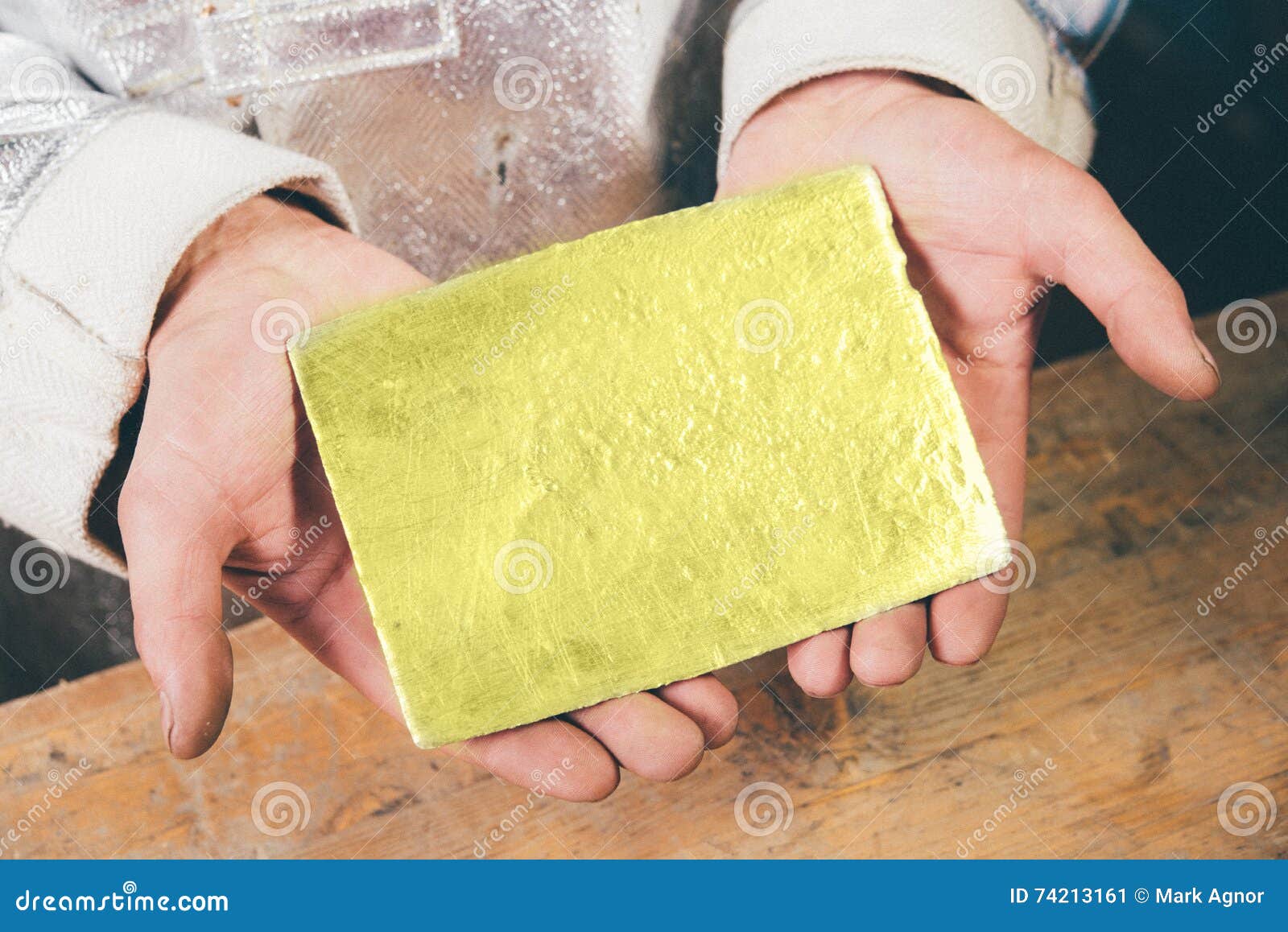 Gold ingot in hands stock image. Image of hold, luxury - 74213161