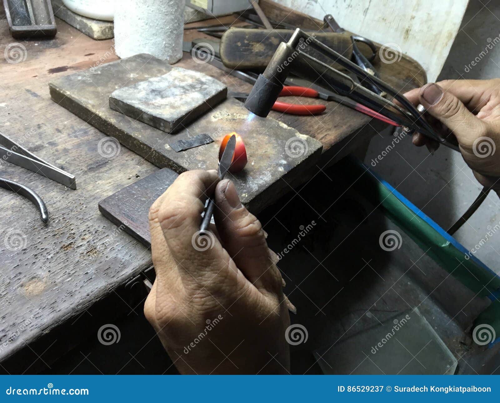 A Gold Making Worker is Firing on the Gold Ring To Adjust Its Si Stock ...